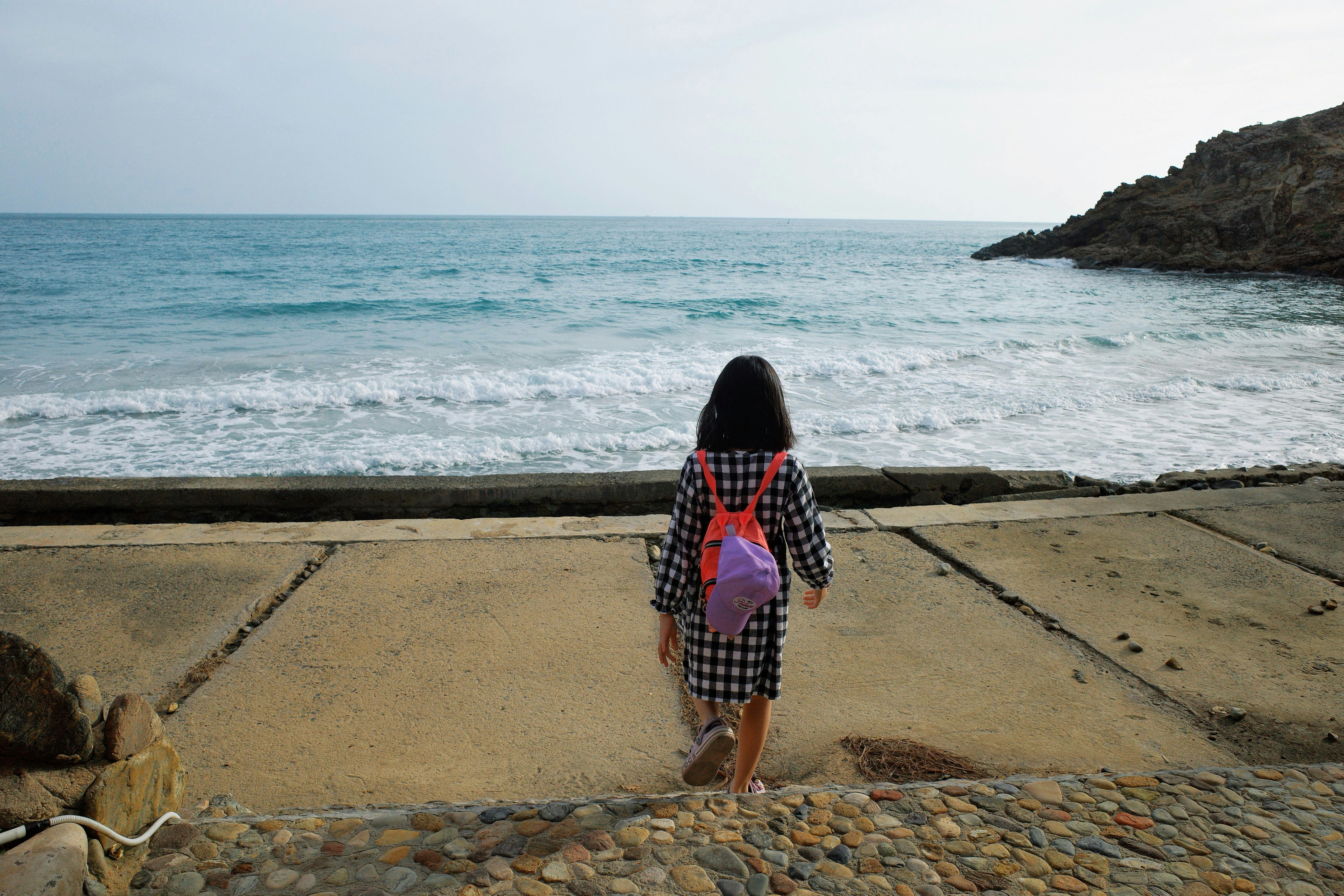 Backpack Climber at the Sea Wall
