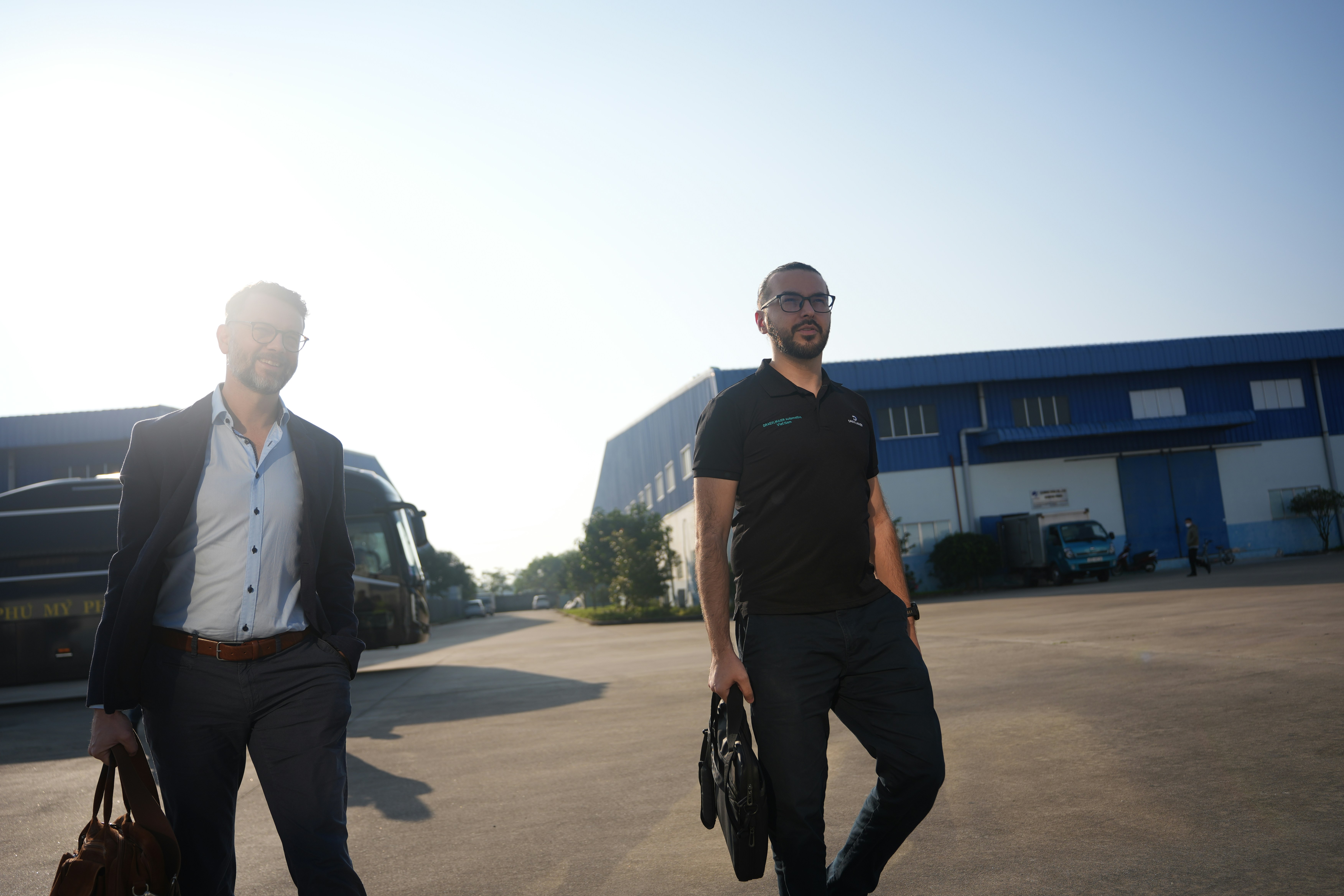 Two Executives Walk Forward as Daylight Basks a Courtyard