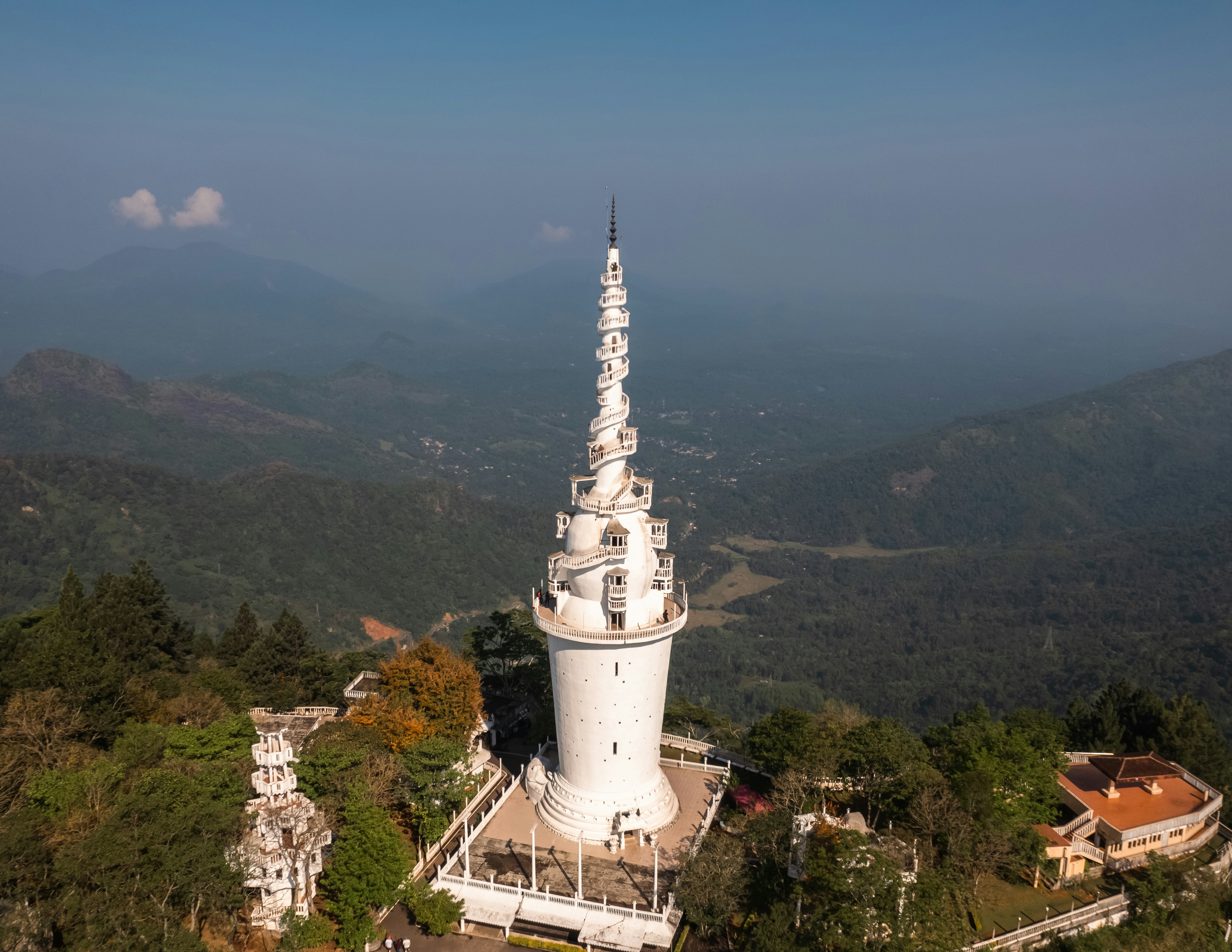 Spire of Silence: Aerial View of the Tower Rising Above Forested Valleys