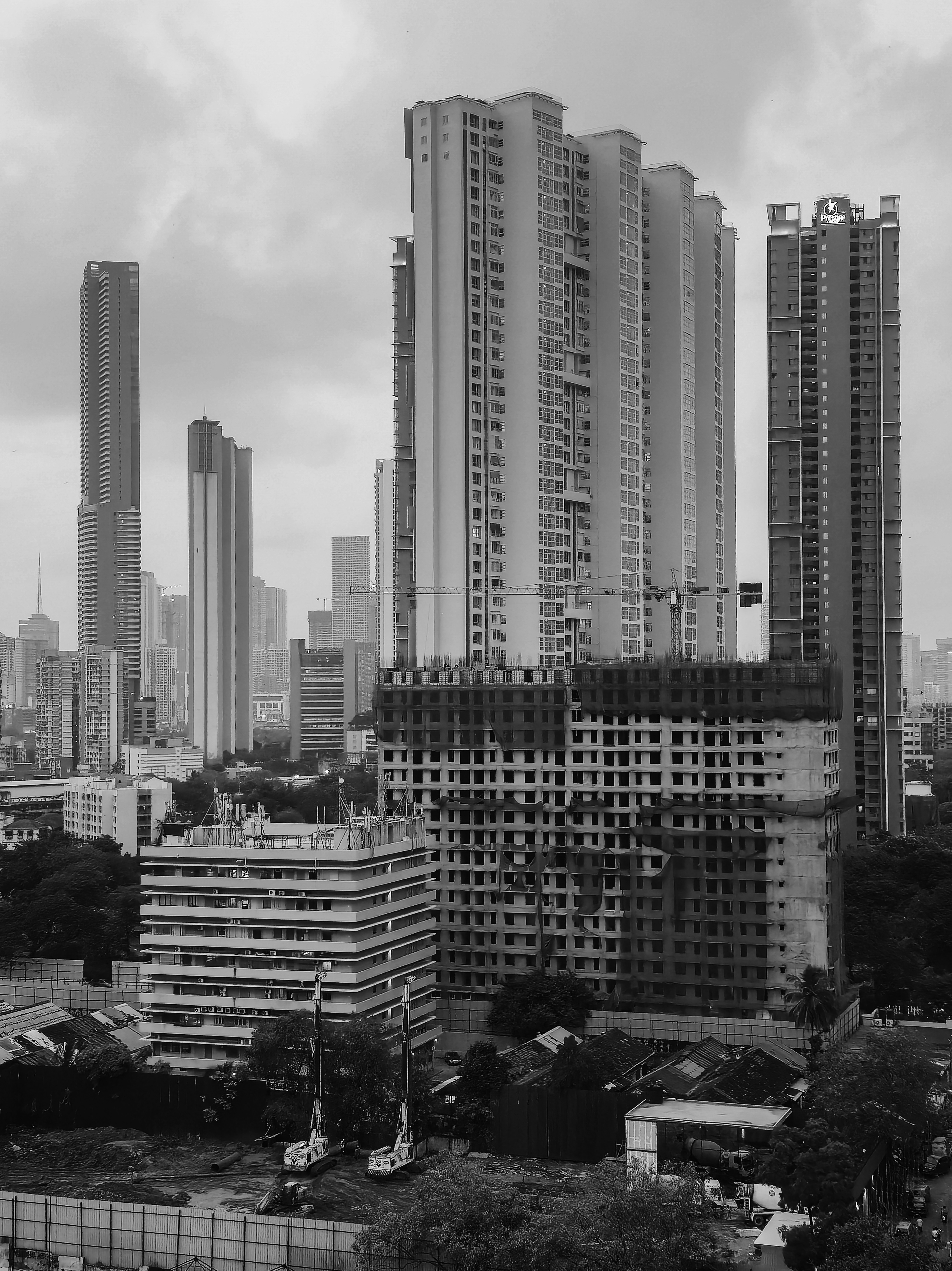Under Construction Skyline: Towers Rise Over a Dappled Cityscape