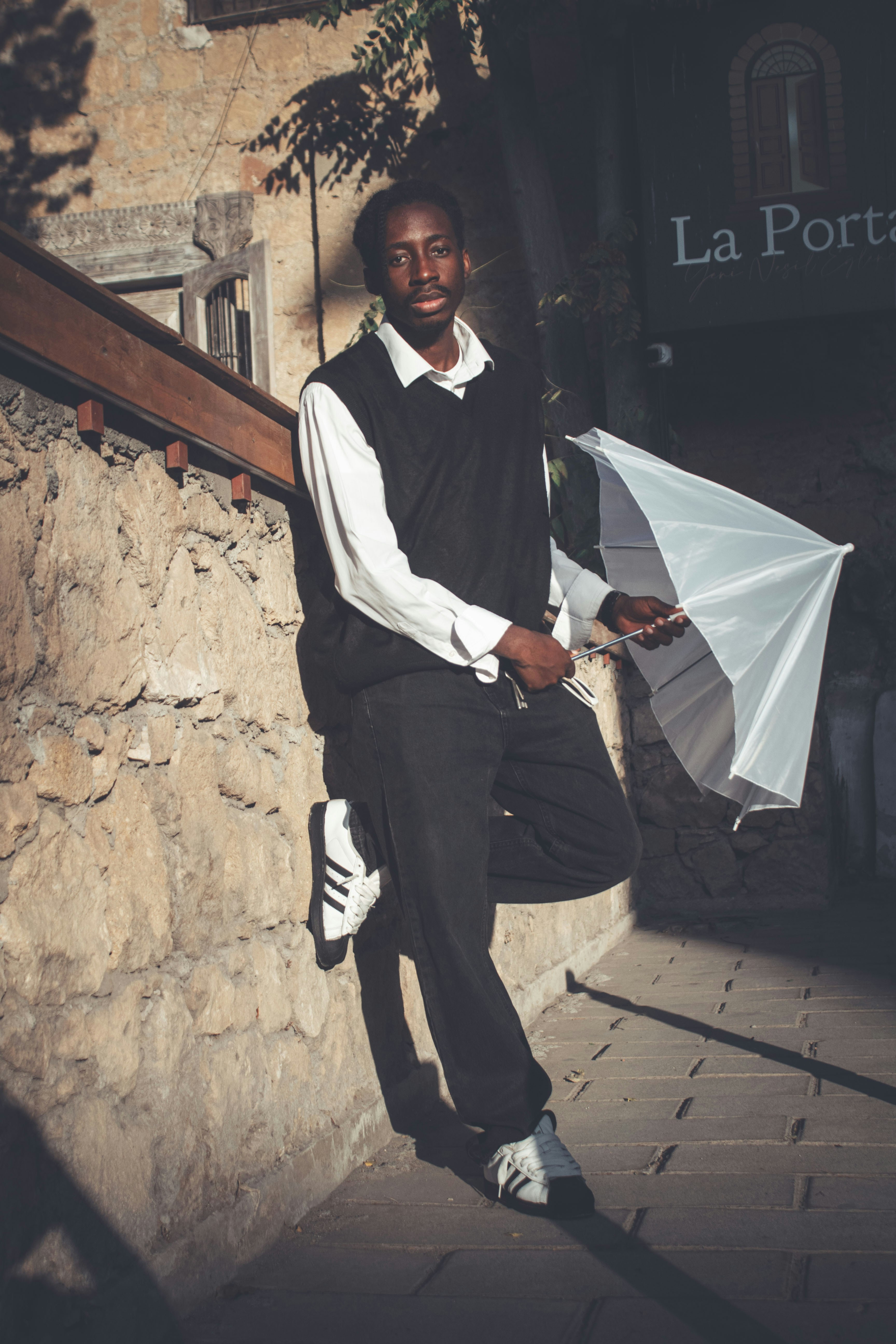 Umbrella of Confidence: A Casual Pose on a Sunlit Street
