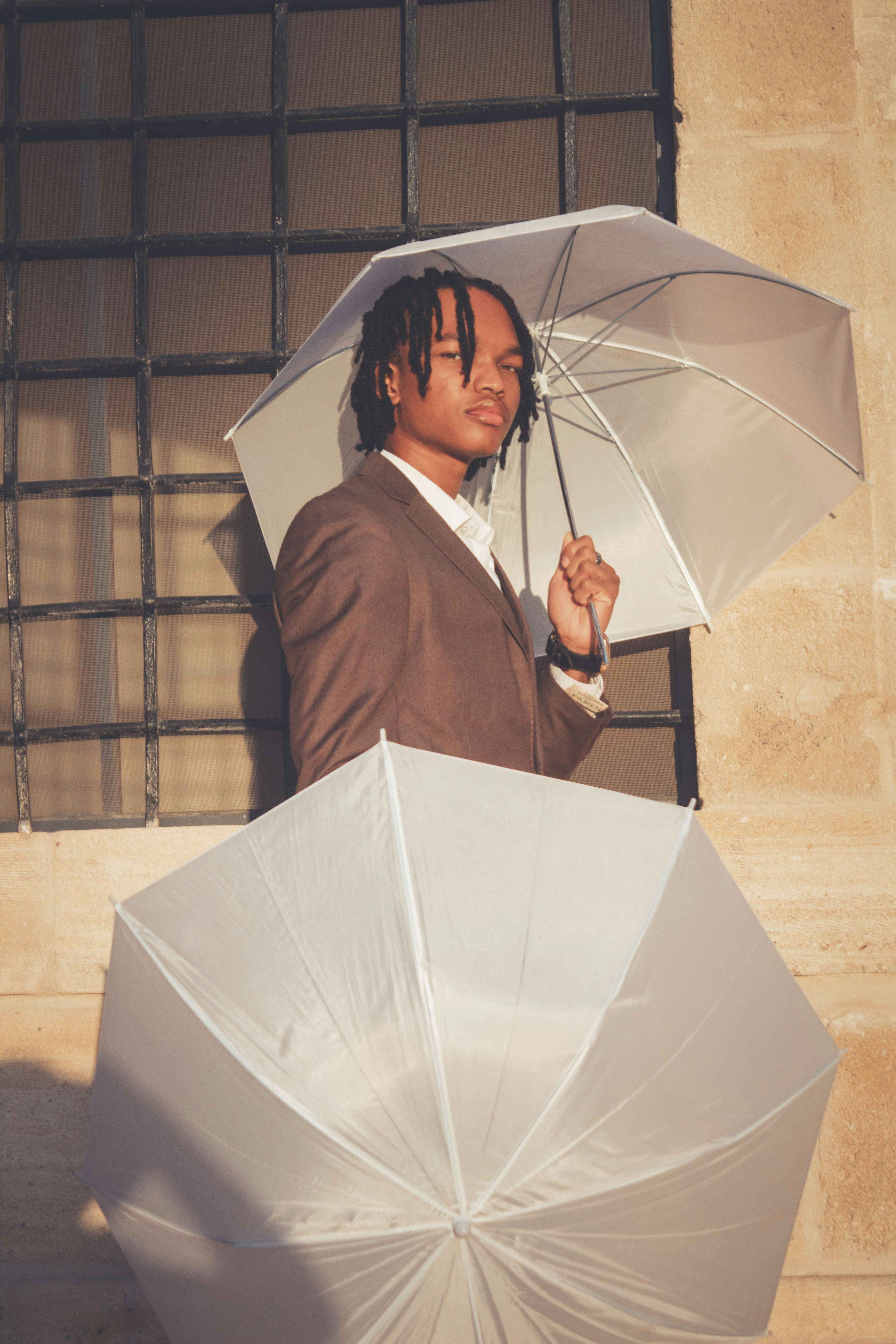 Umbrella Portrait: Poised in Light and Shadow