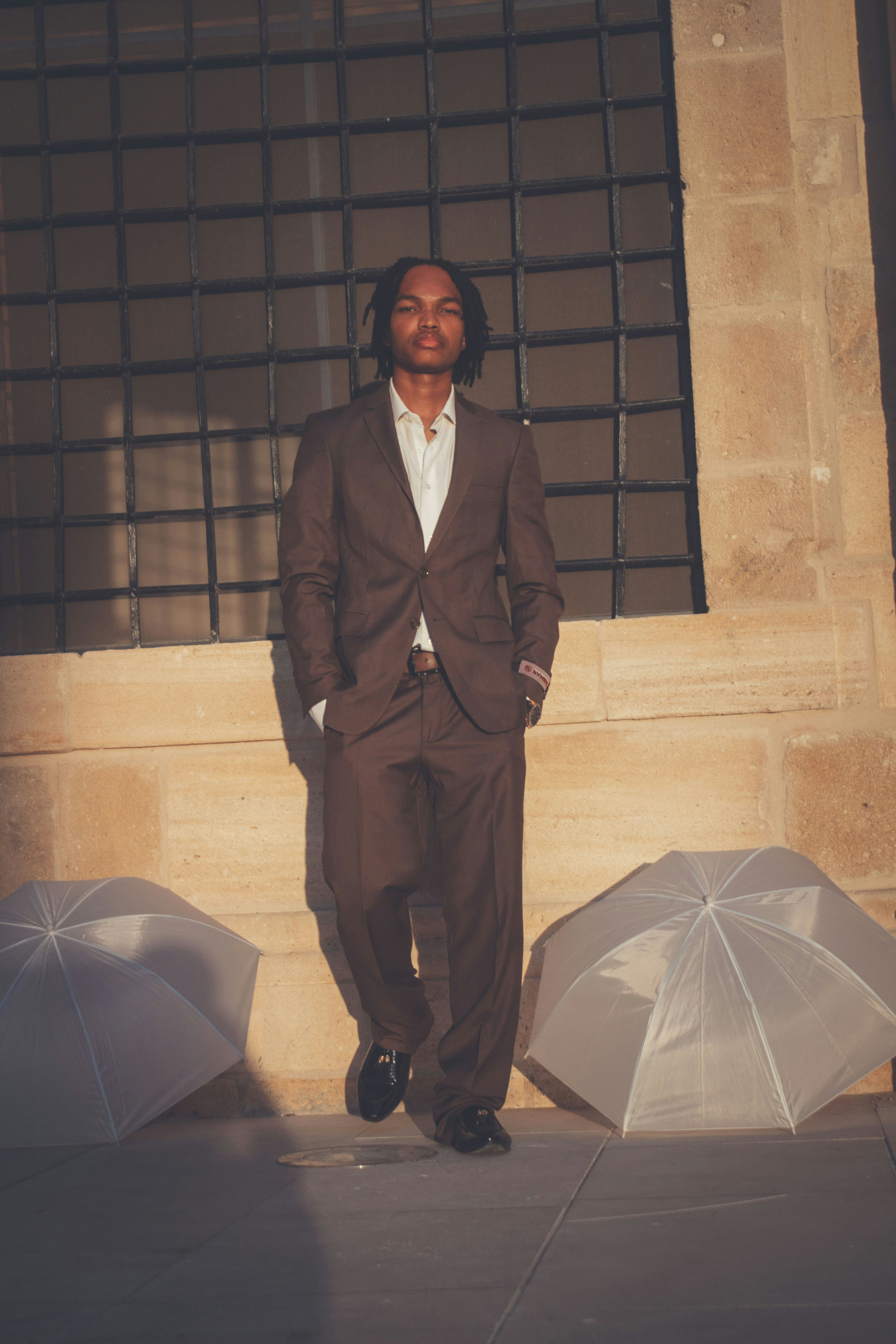 Sleek Confidence: A Dressed-Down Portrait by the Windowed Wall