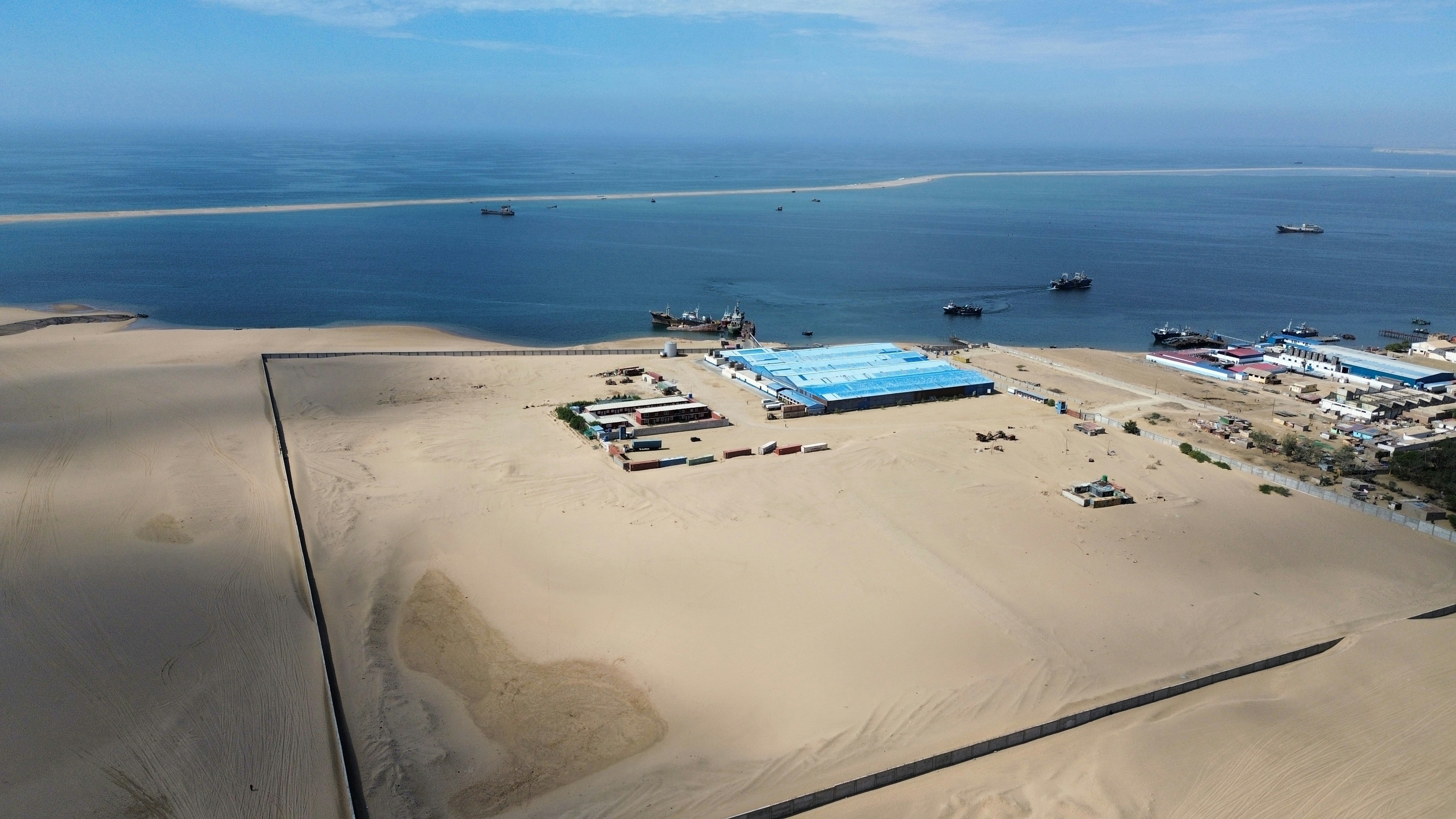 Coastal Portside Playground: A Beachfront at Low Tide with Distant Vessels