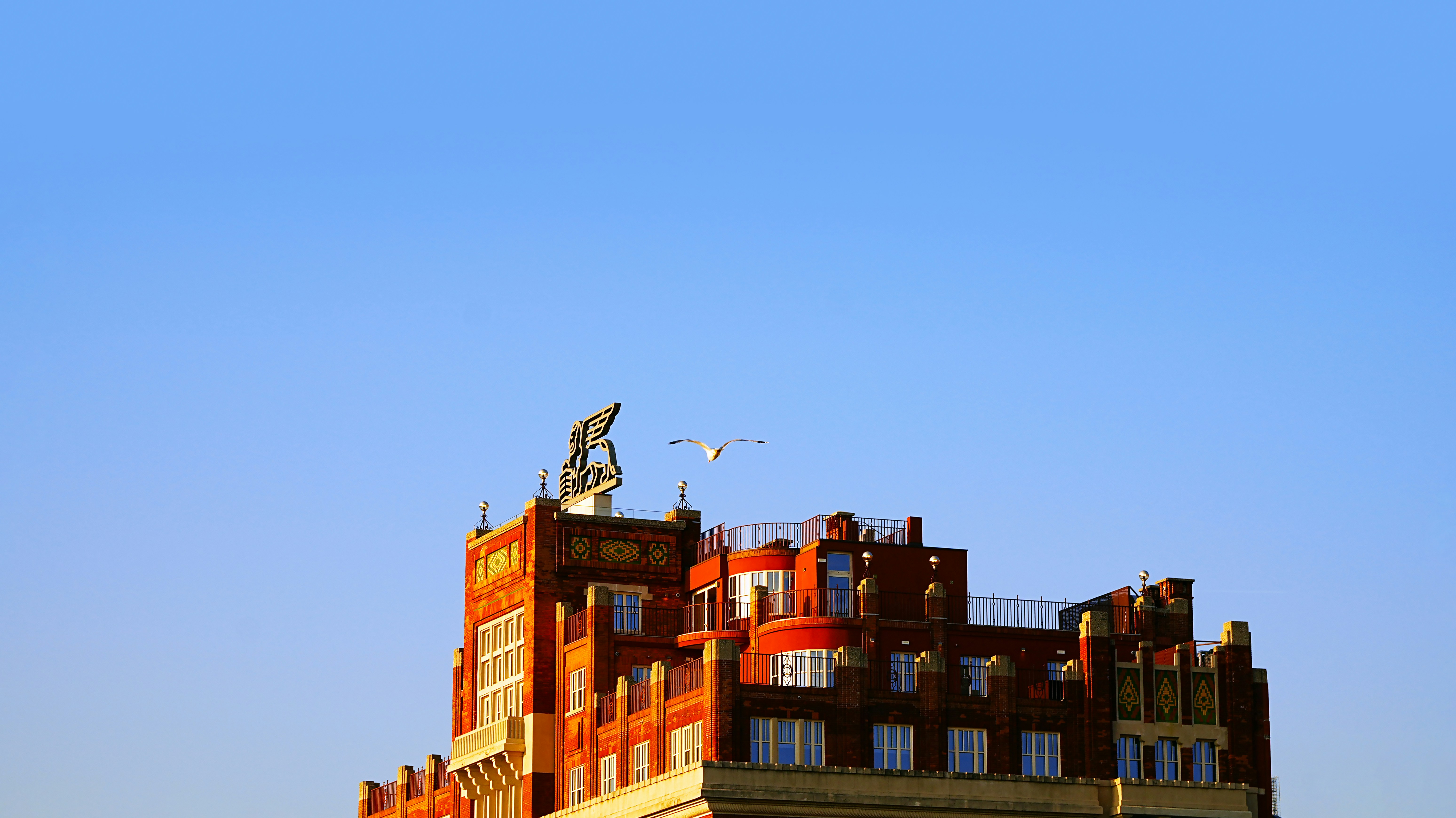Brick City Crest: Rooftop Perspective Over a Sunlit Urban Silhouette