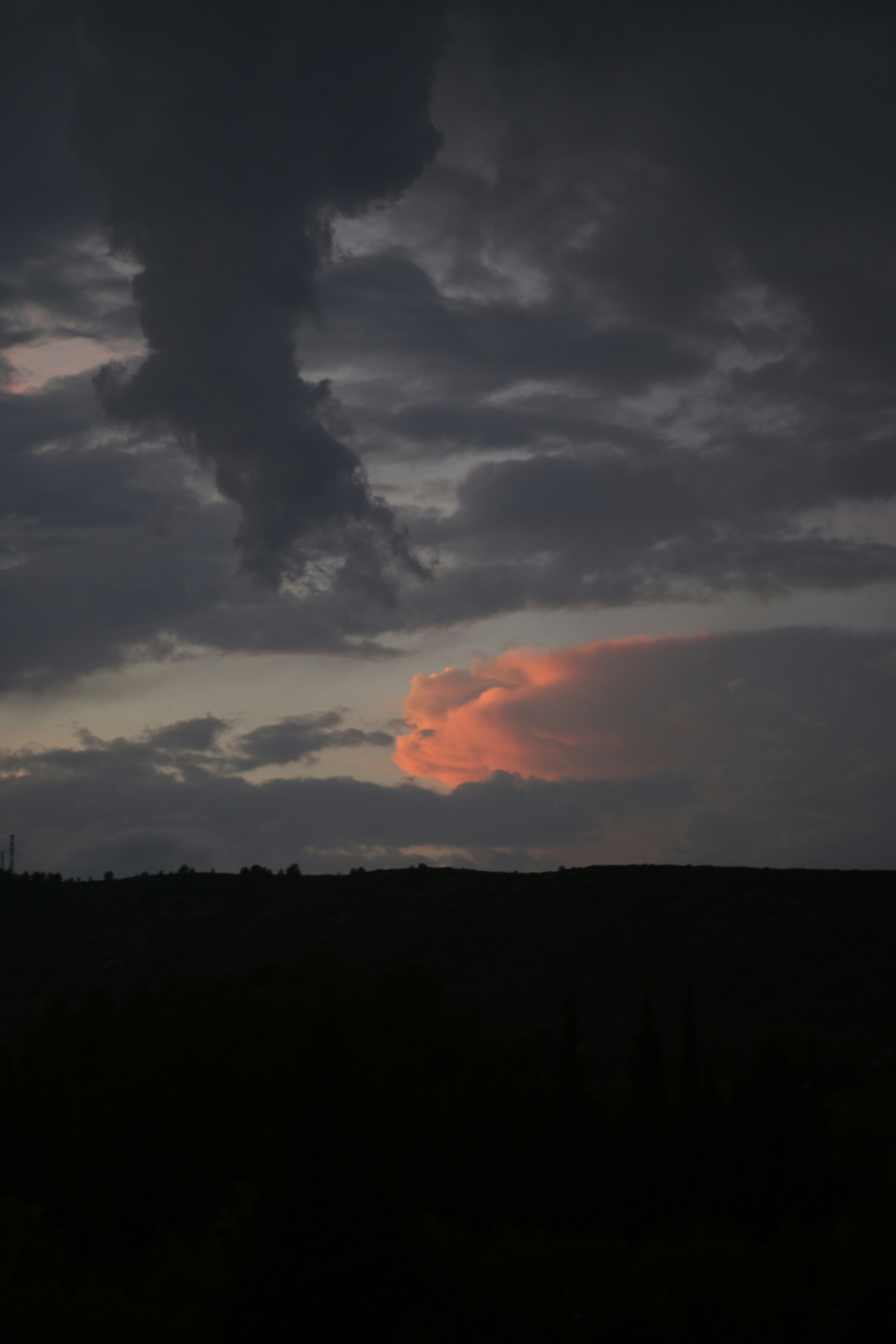 Low-Cloud Sunset: A Quiet Horizon with a Smoky Storm Emergence