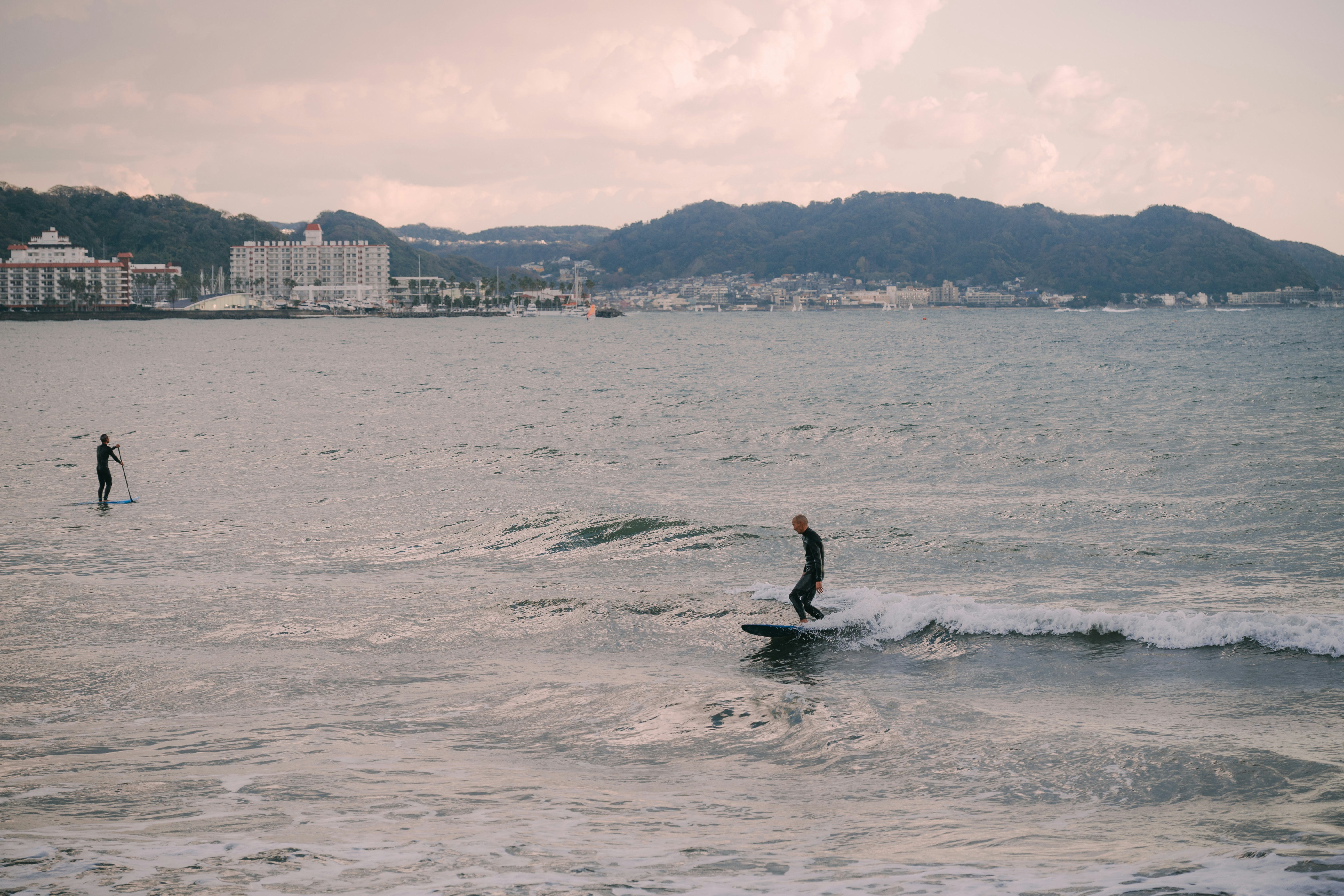 Surfer in the Pacific, a Quiet Moment Before the Shoreline City