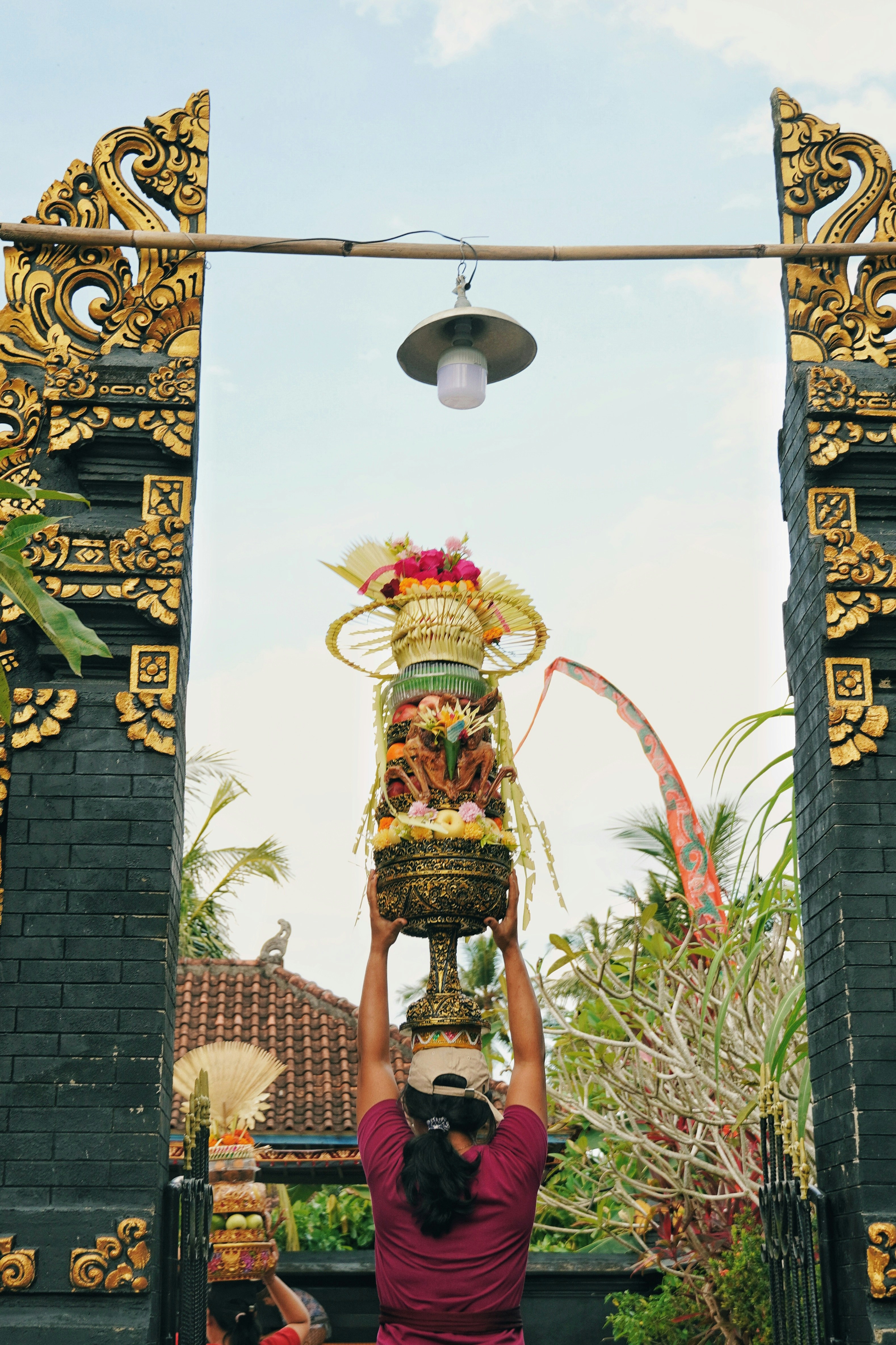 Ritual Crest: A Balinese Carrier Elevates a Sacred Arrangement