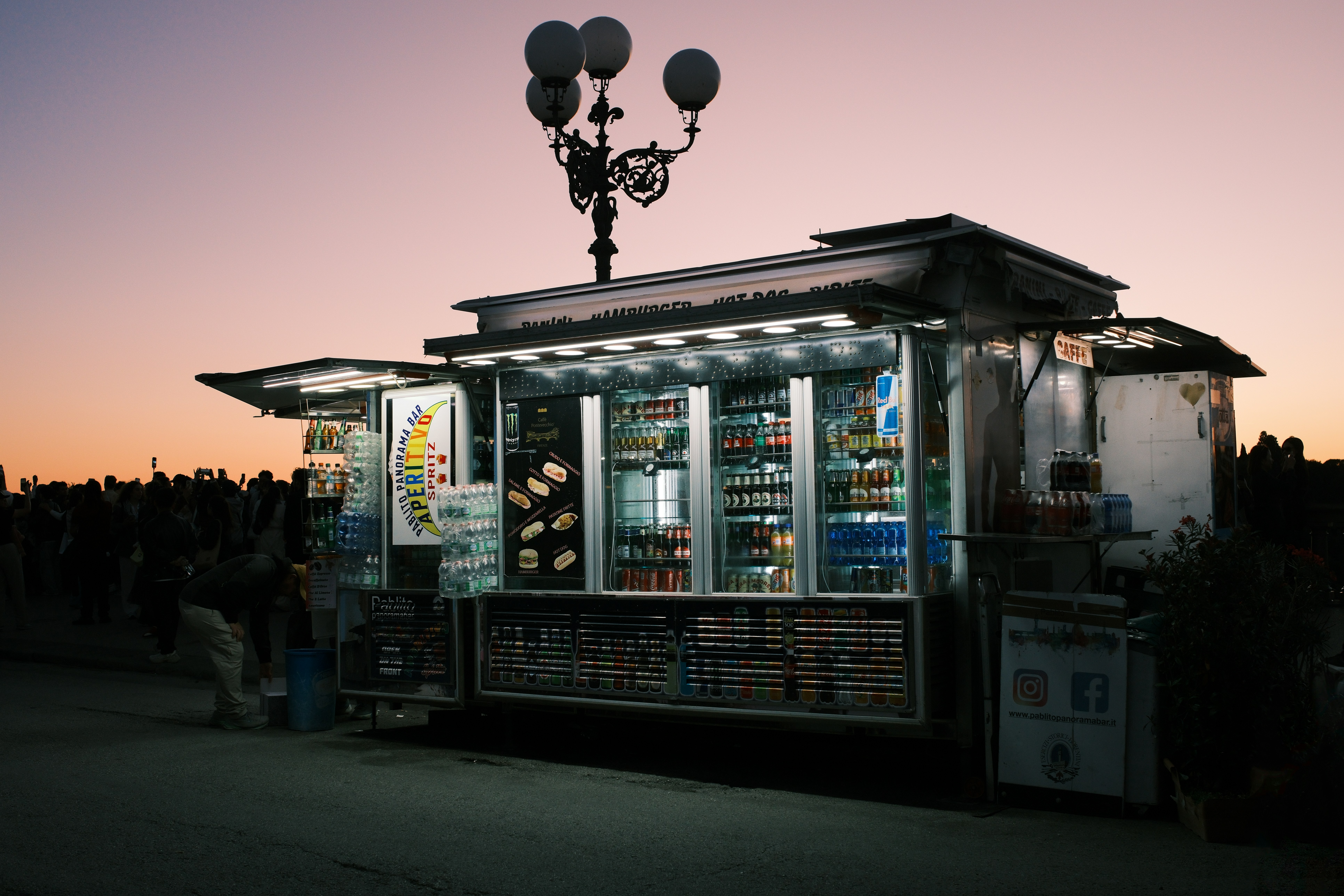Evening Snack Cart Under a Crescent of Streetlamps