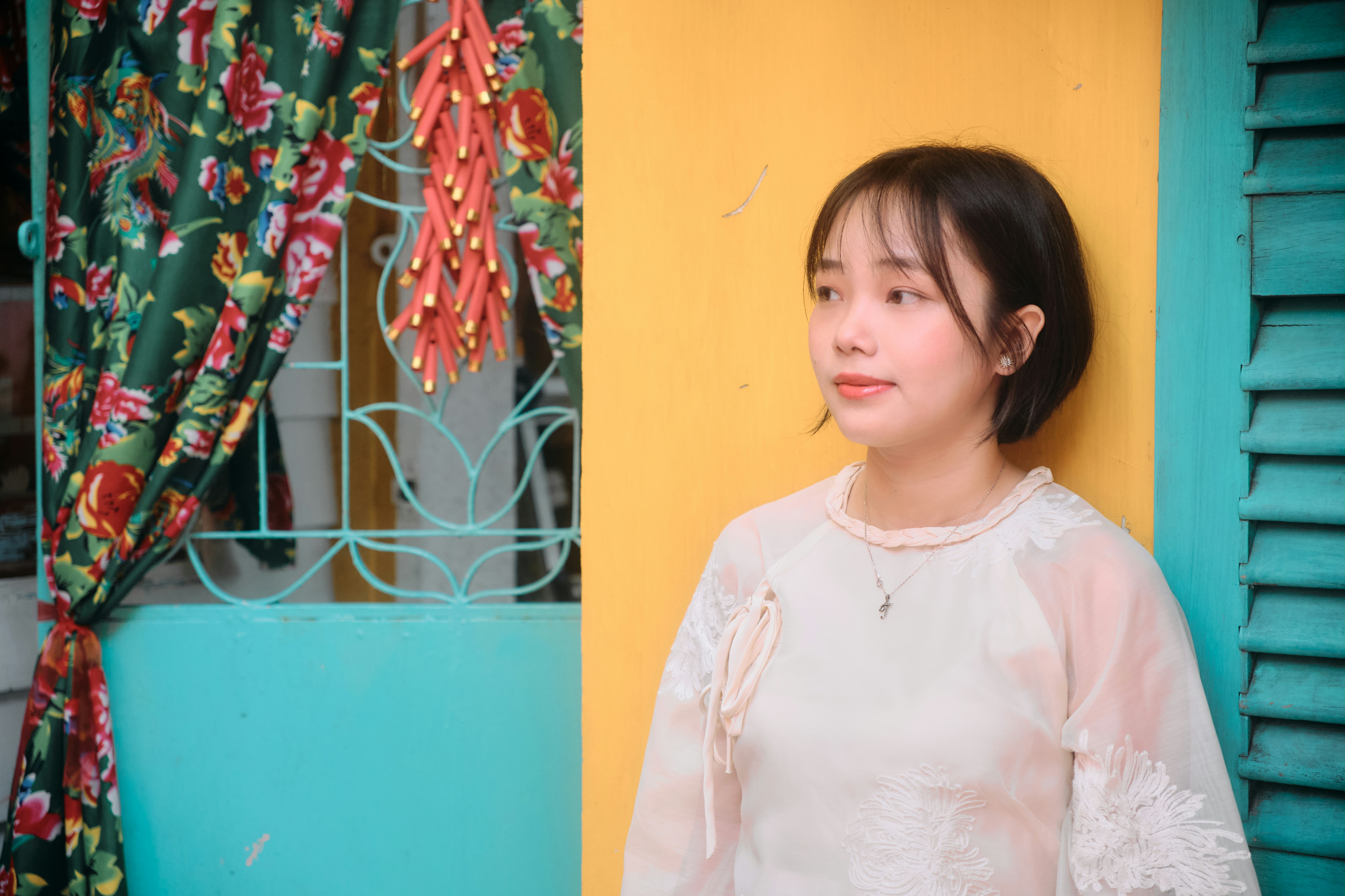 Sunlit Portrait Against a Colorful Doorway