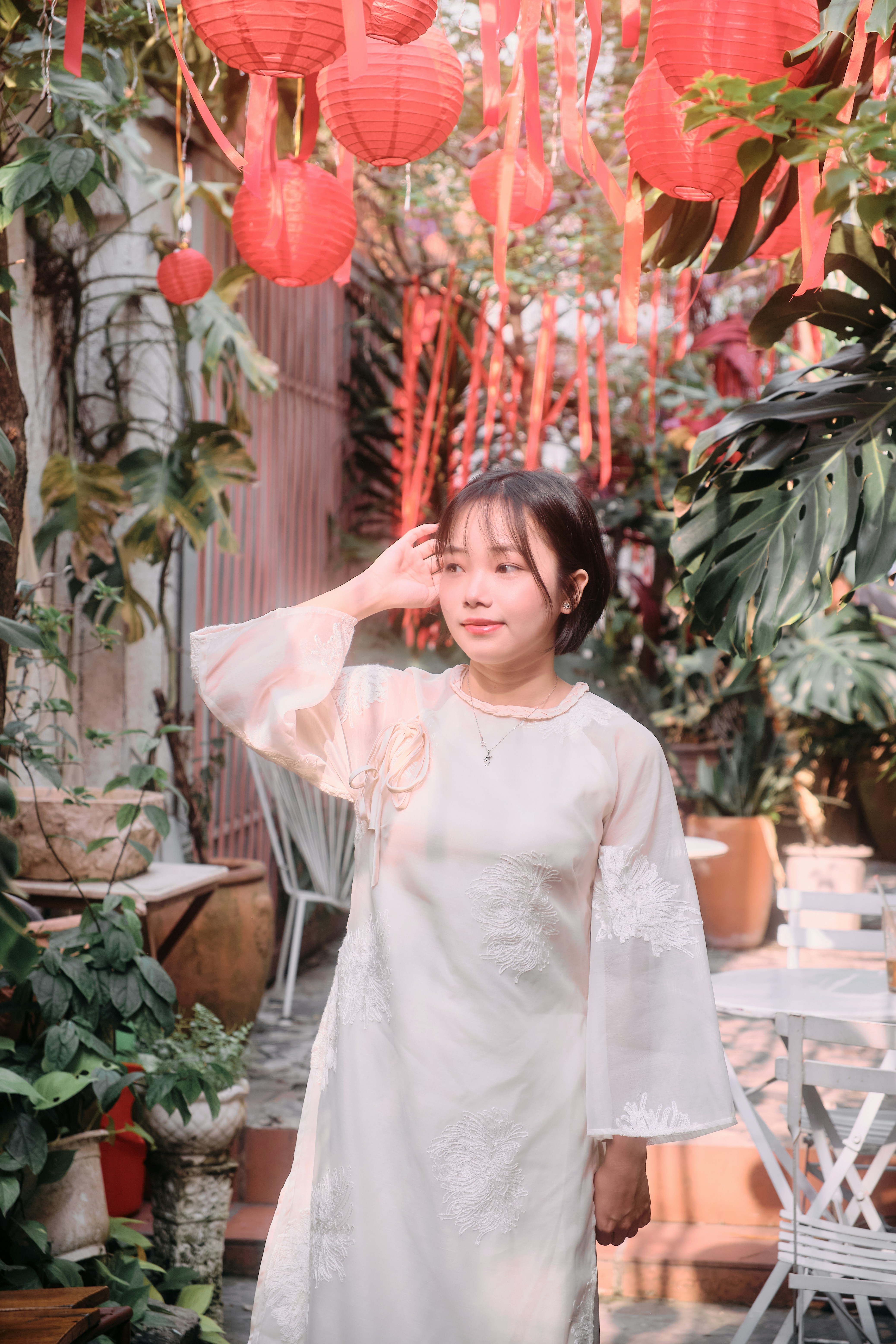 Soft Poise Under Lanterns: A Portrait in Peach Silk