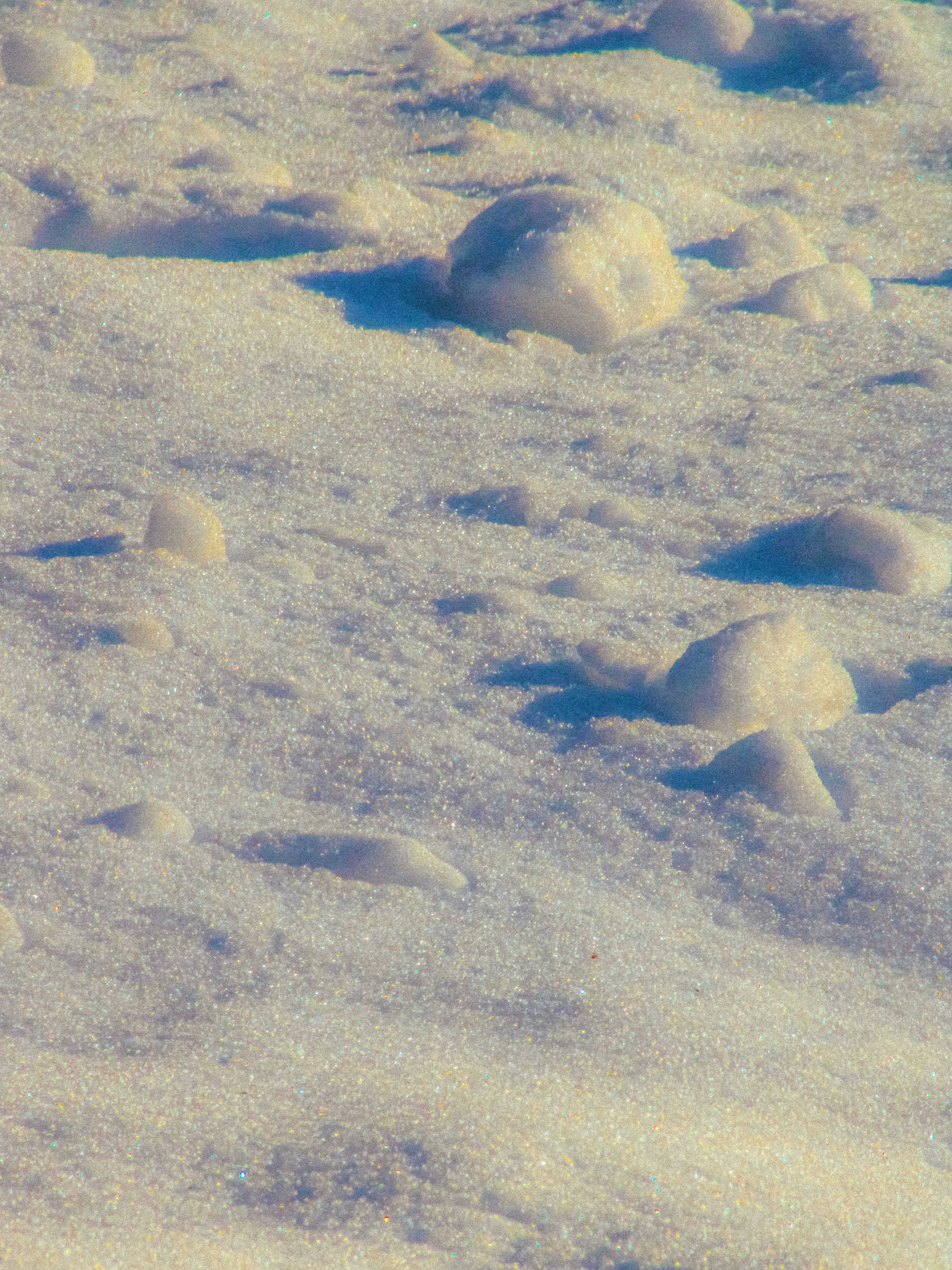 Snow-dusted mounds under soft twilight light