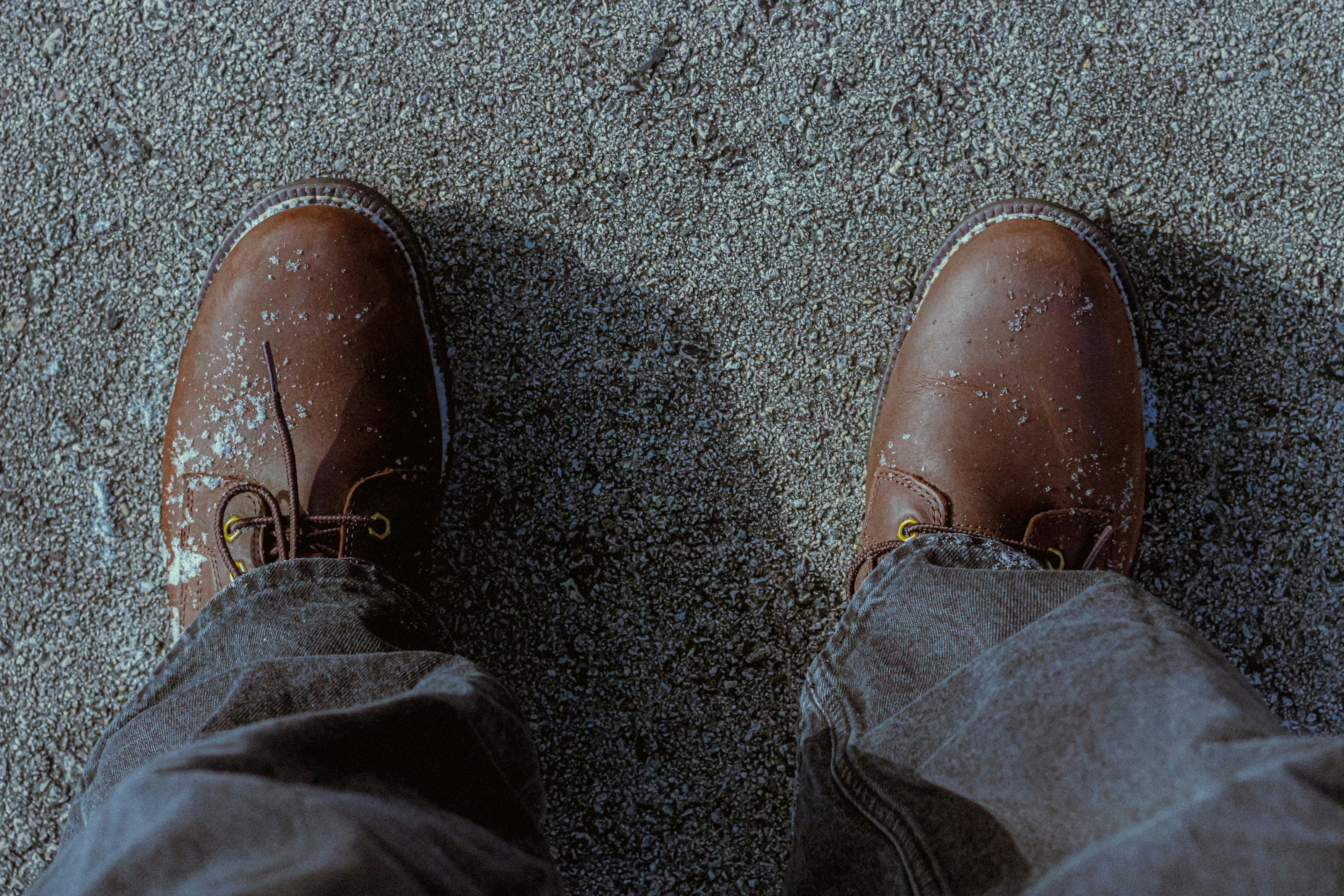Centered Steps: Brown Leather Boots on Gravel