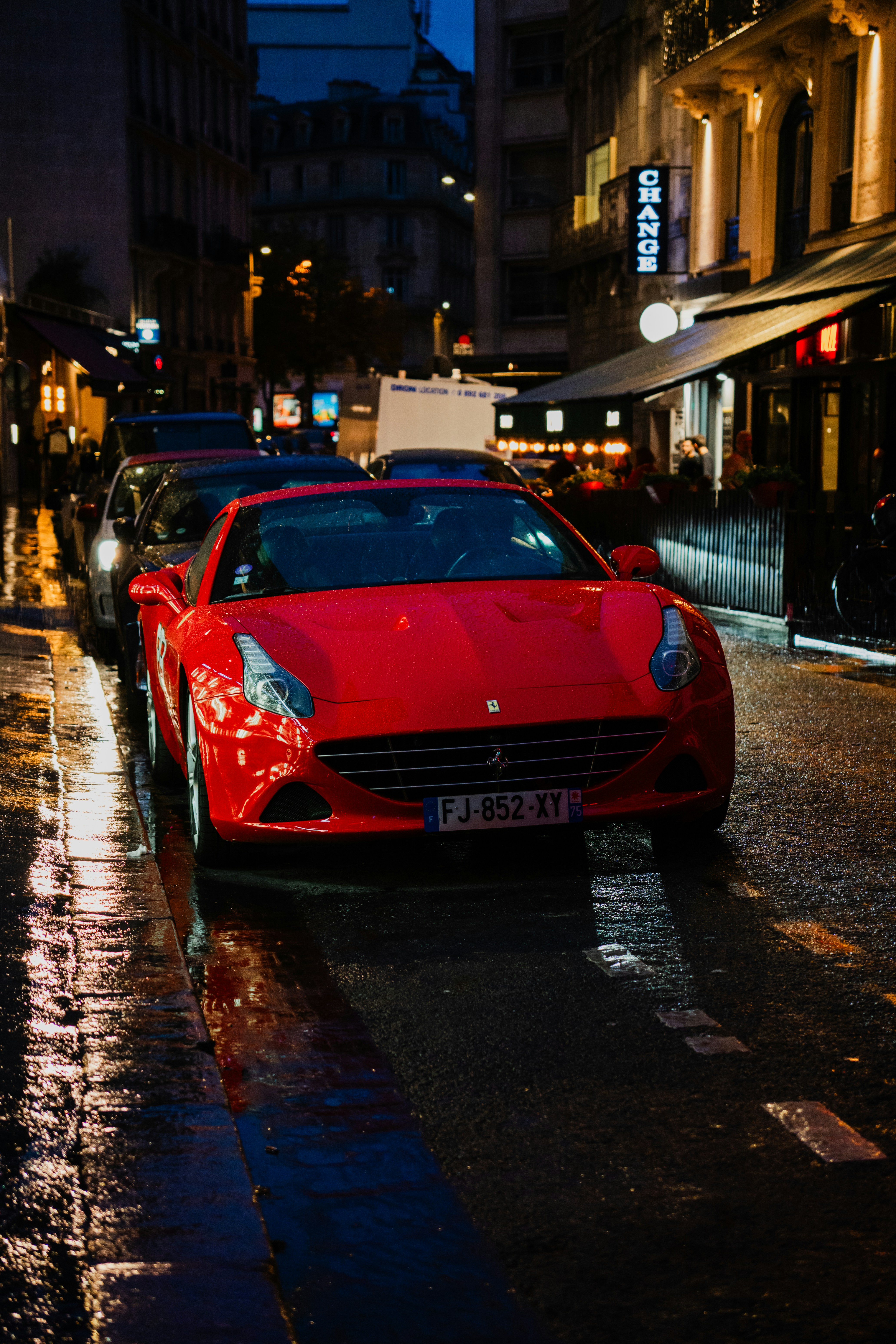 Red Ferrari at Rain-Slick Parisian Night