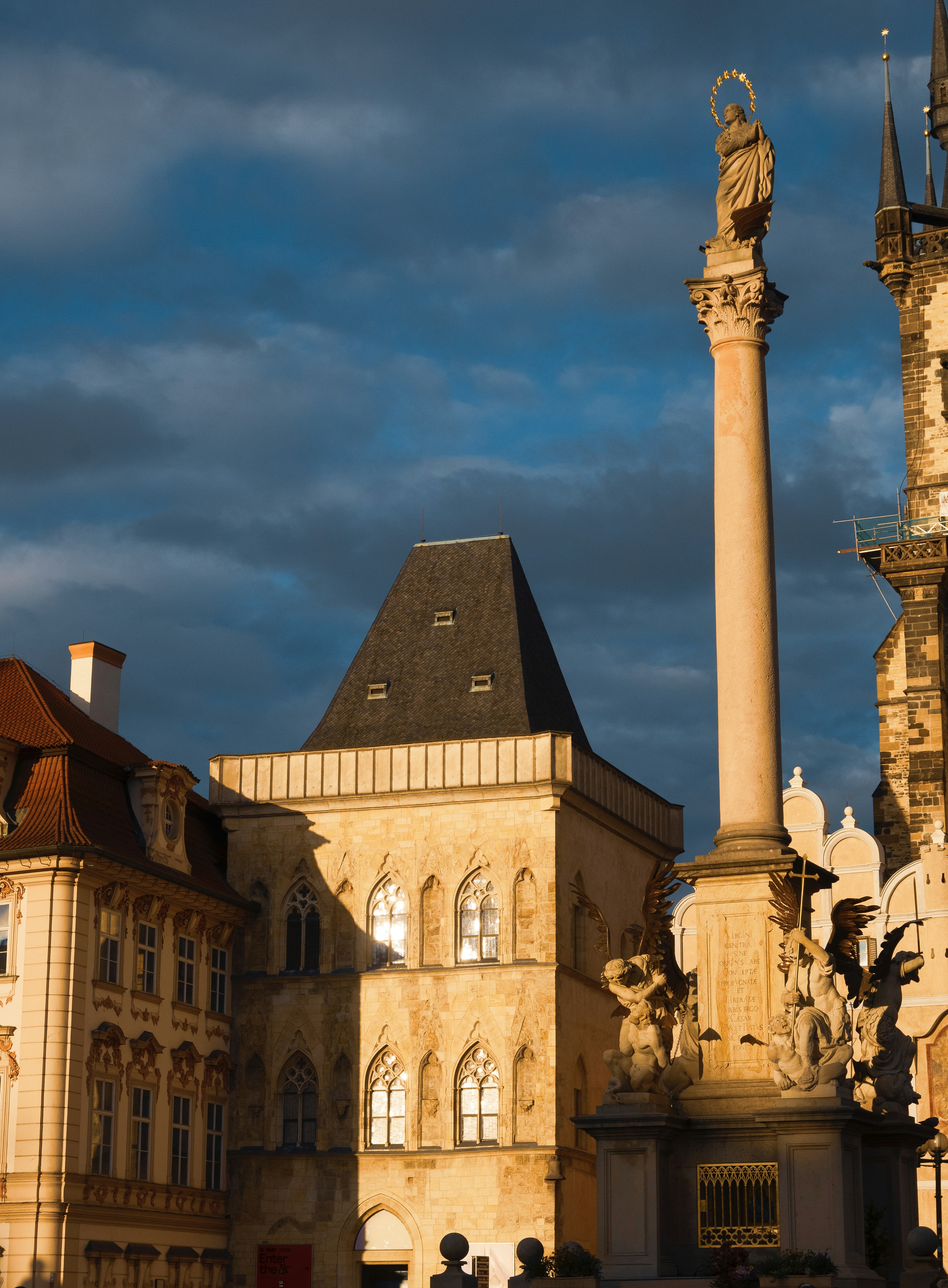 Baroque Monument and Cathedral Spire under a Painted Sky