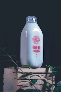 Milk Bottle on a Wooden Crate Under Dark Backdrop