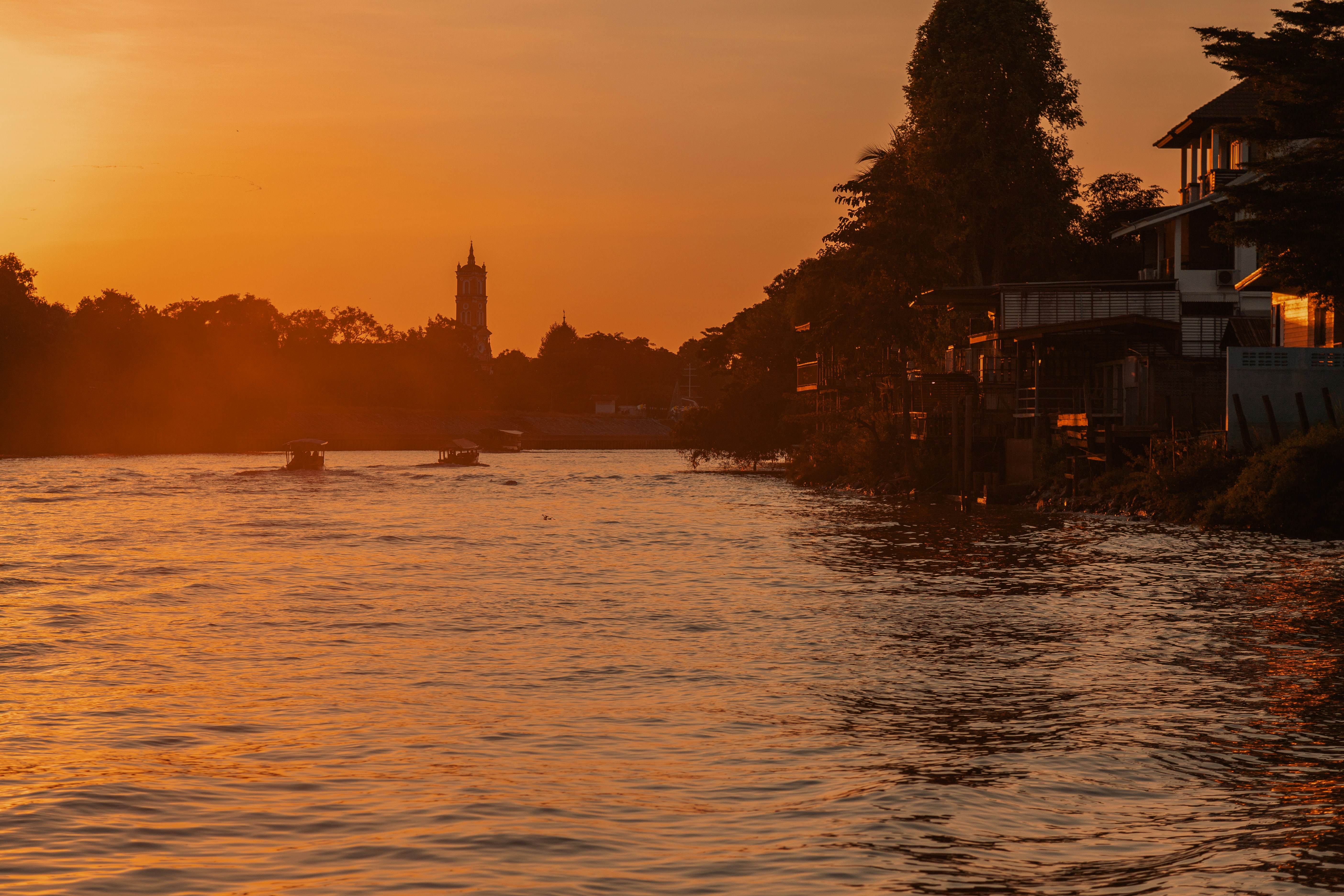 Sunset Over a Quiet Waterway with Riverside Buildings