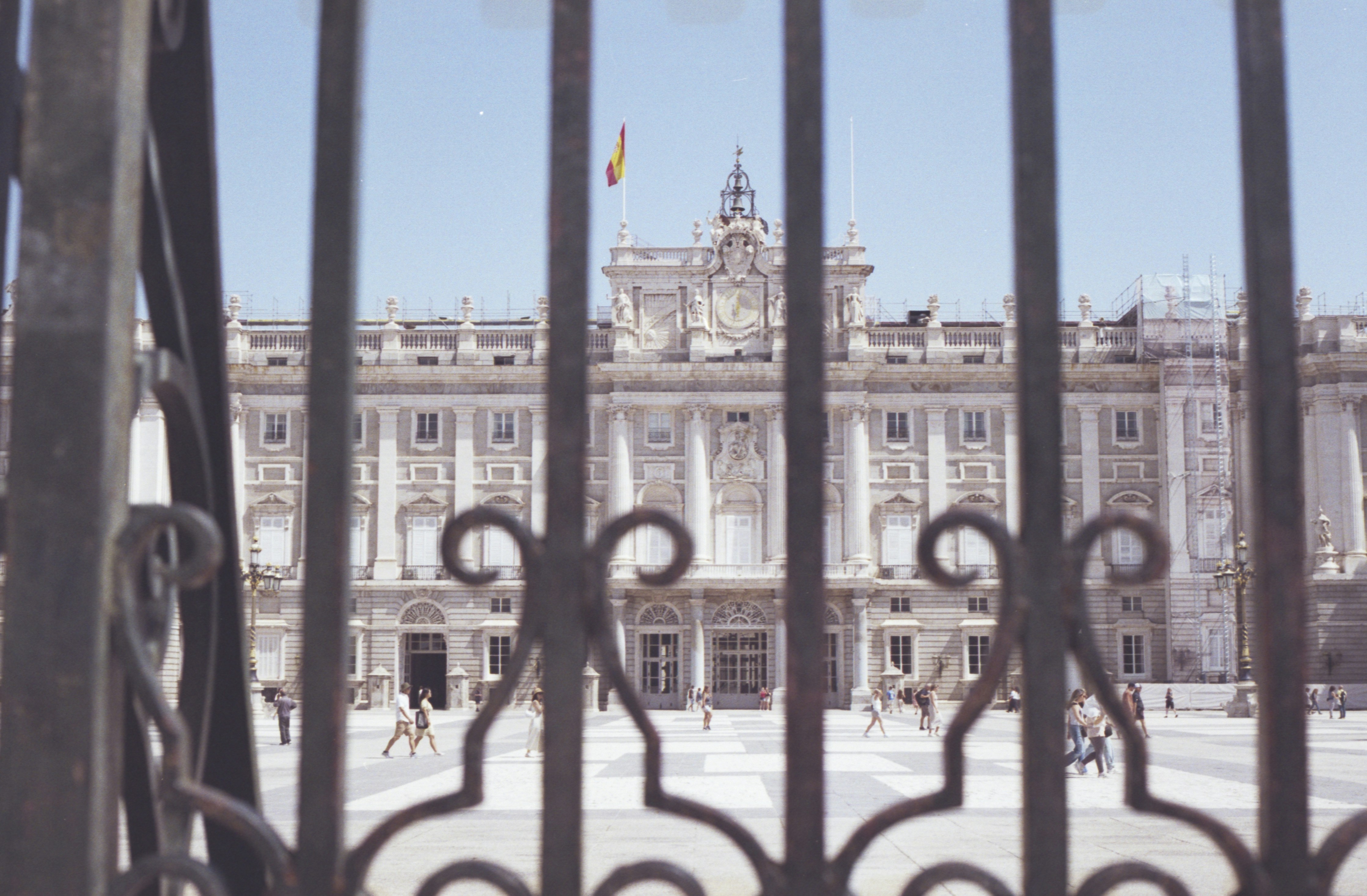Ornate gate in front of a grand white building