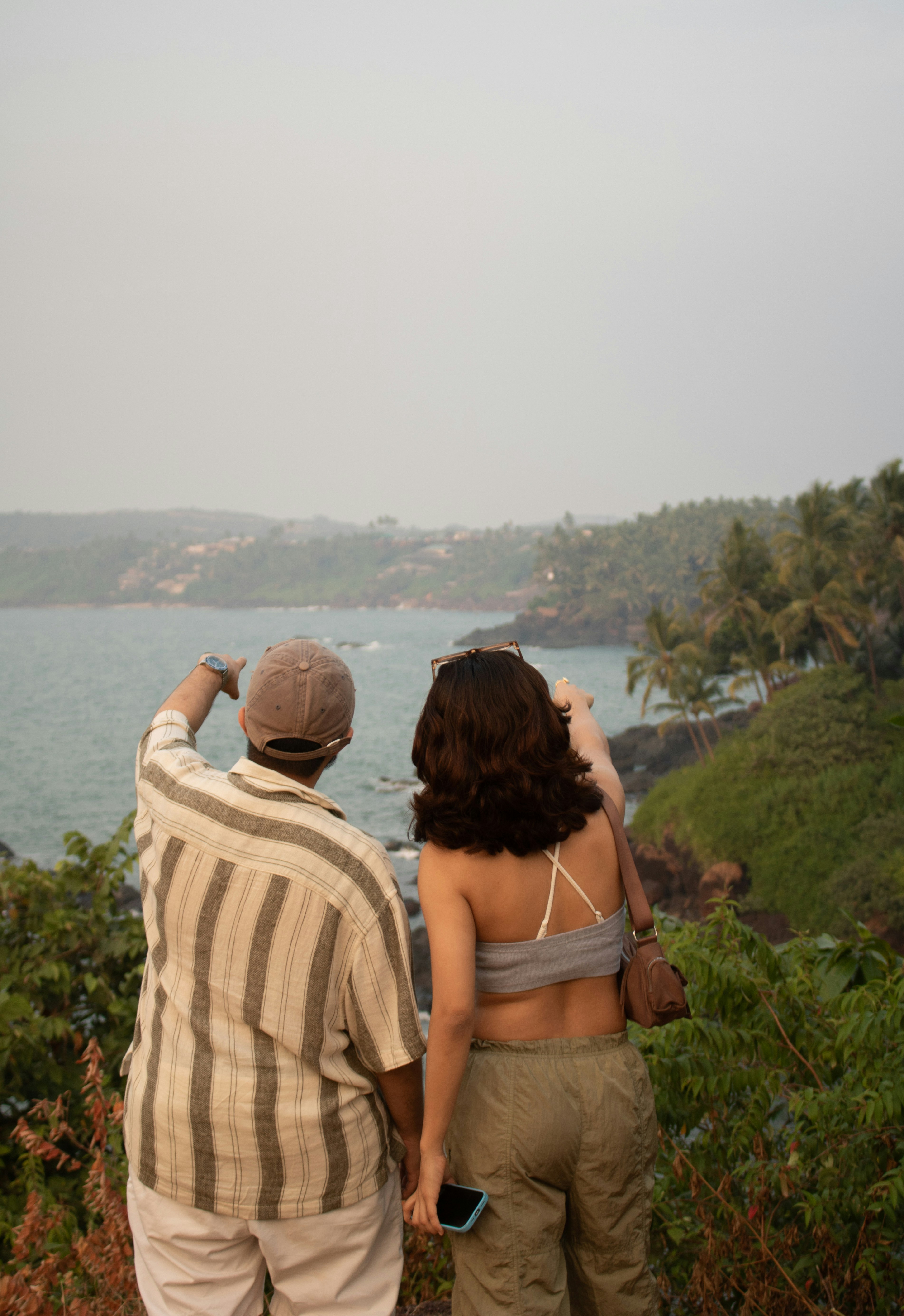 Two Explorers at the Edge of a Lush Coastal Cliffs