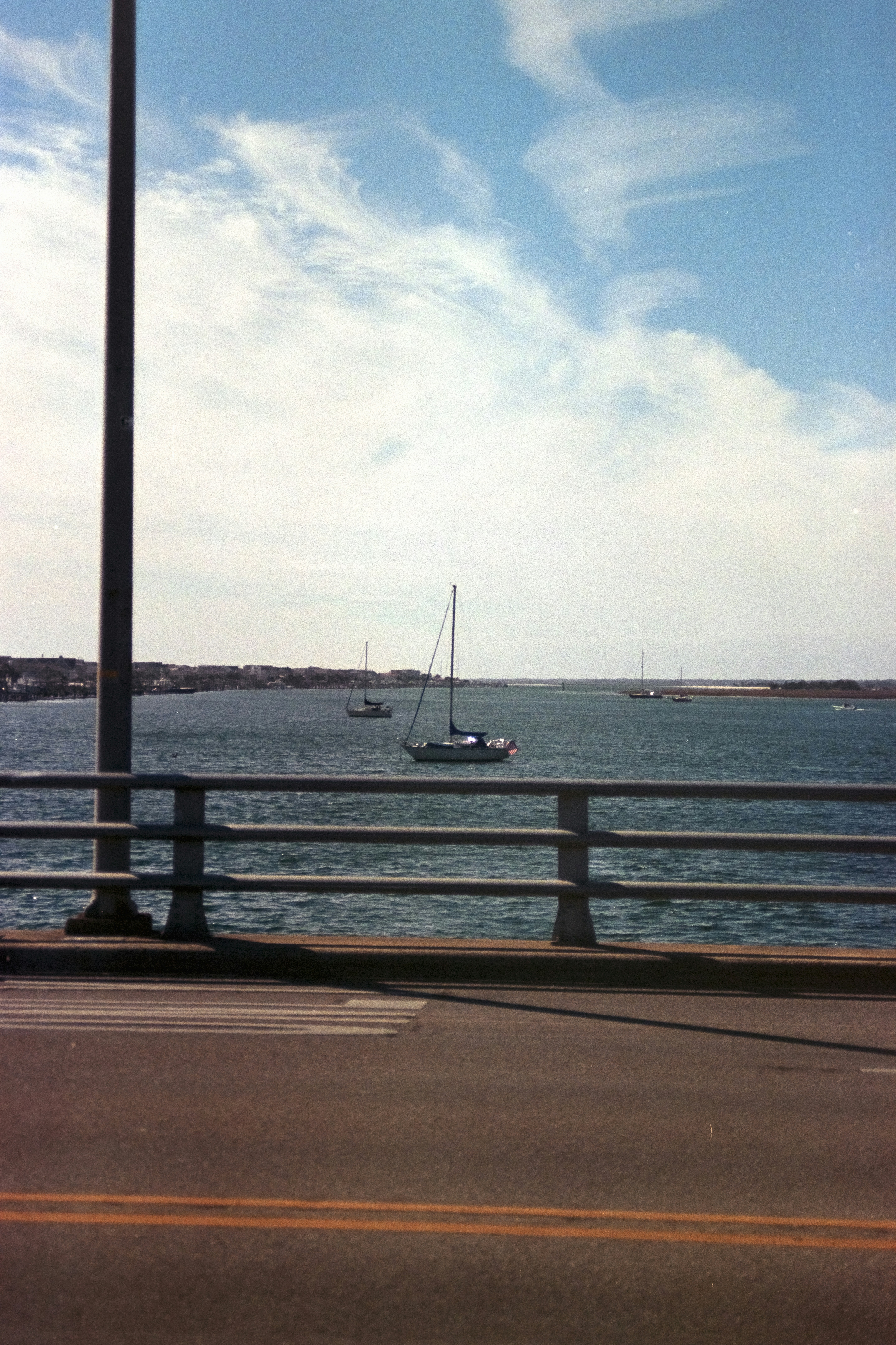 Pier Edge, Sea Sky: Boats, Rail, and a Quiet Horizon