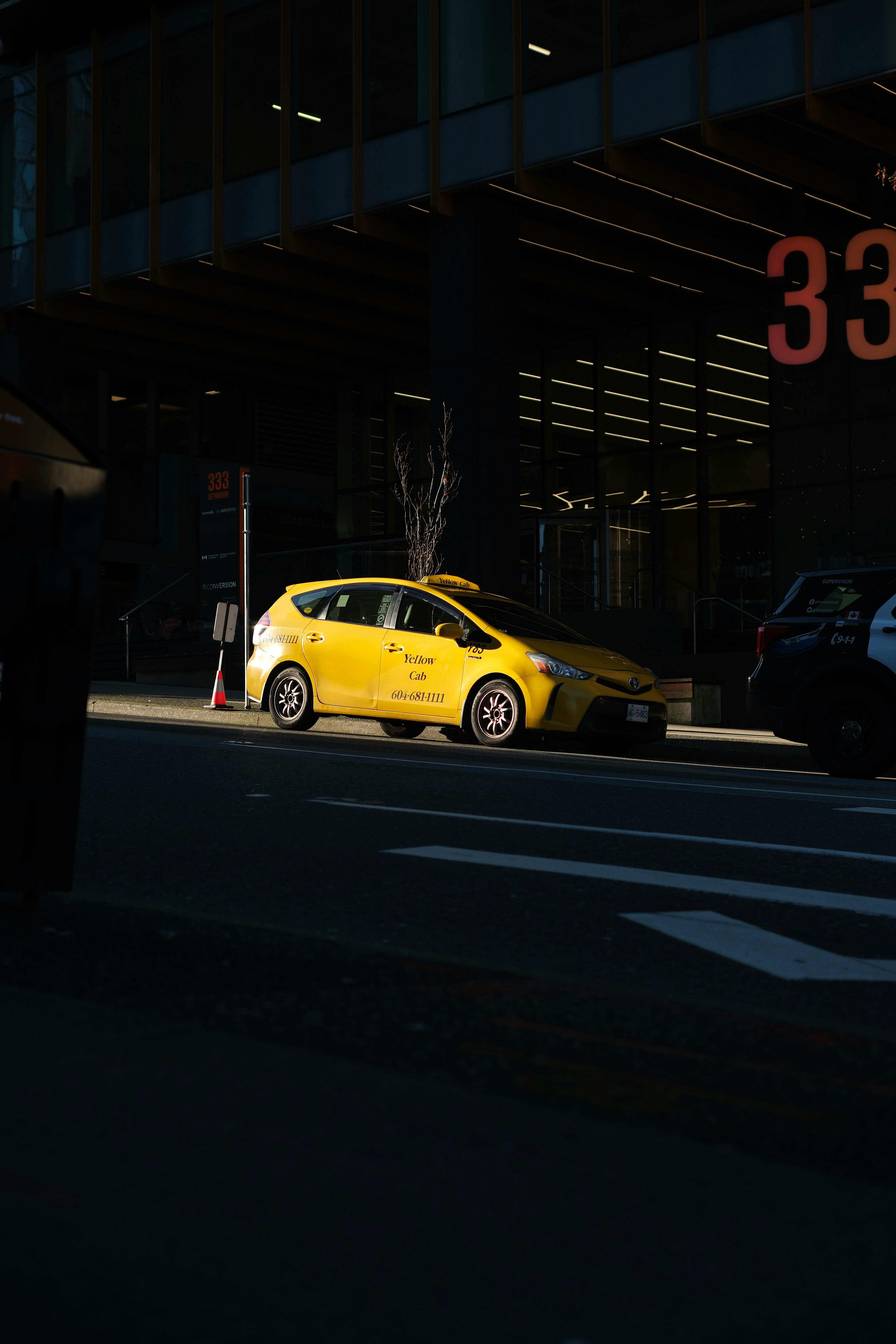 Yellow Taxi on a City Street Bathed in Evening Light