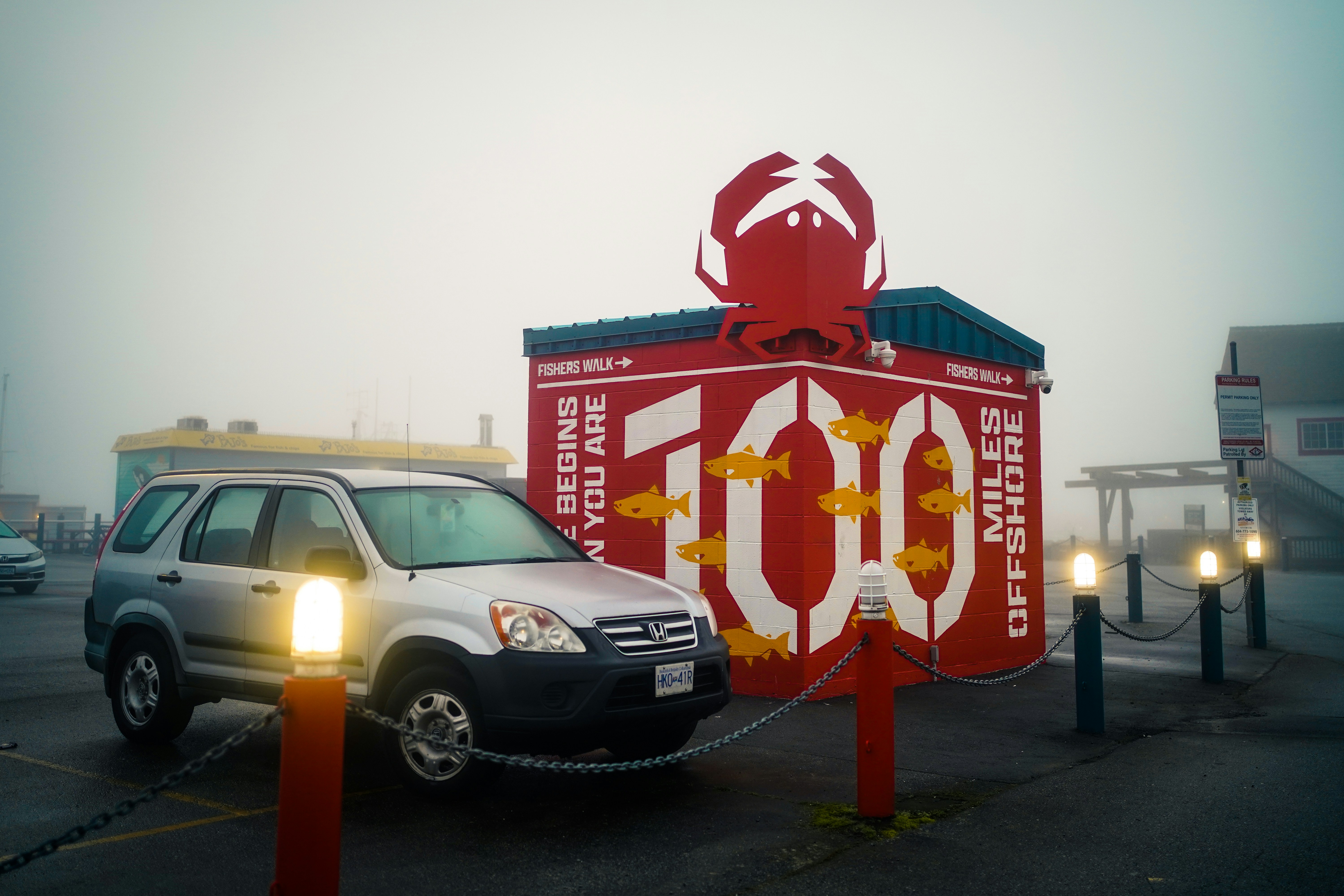 Forty-Year-Old Car and Red Shipping Container Art at a Coastal Pier