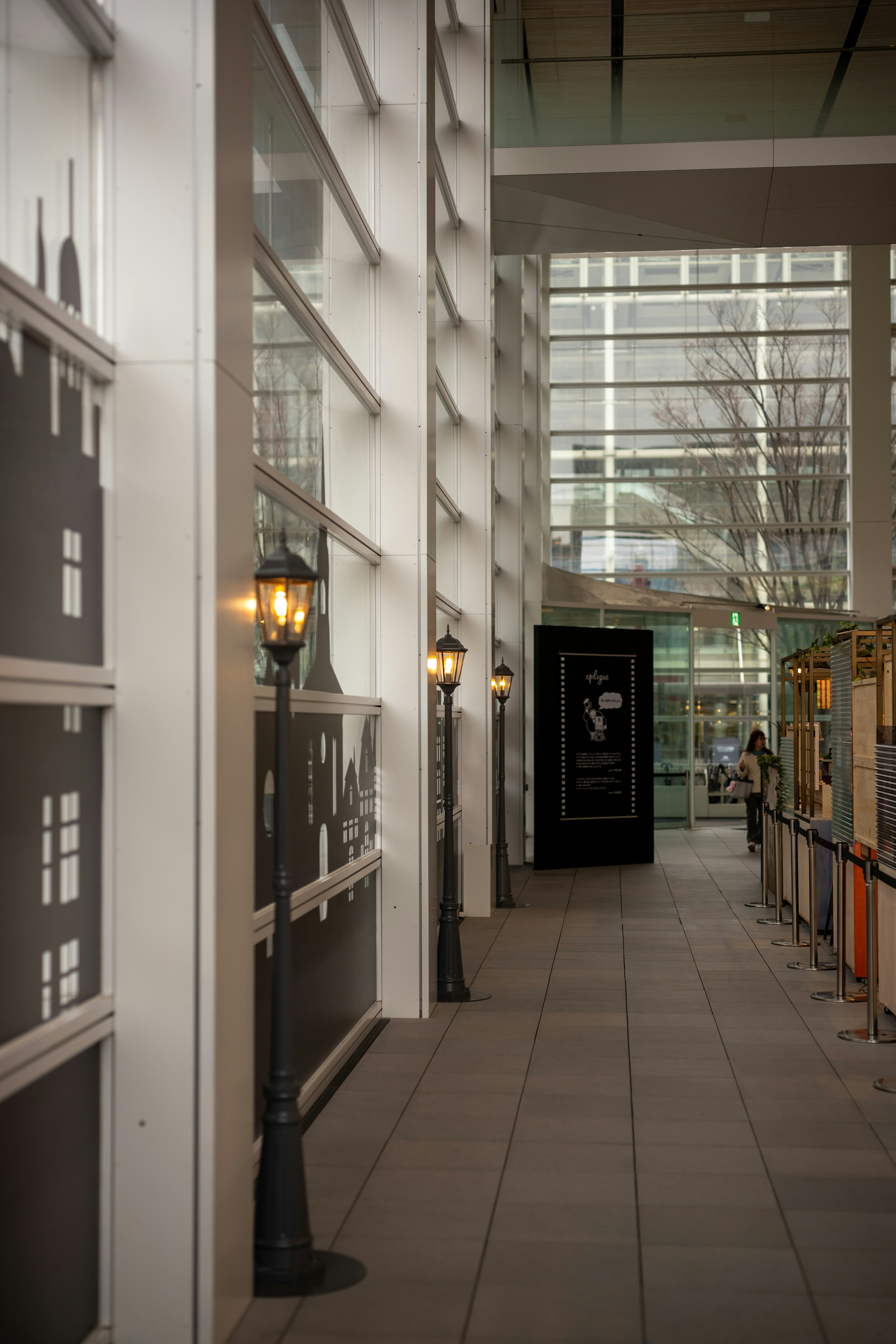 Quiet Corridor of Light: A Studio-like Atrium with Warm Lamp Posts