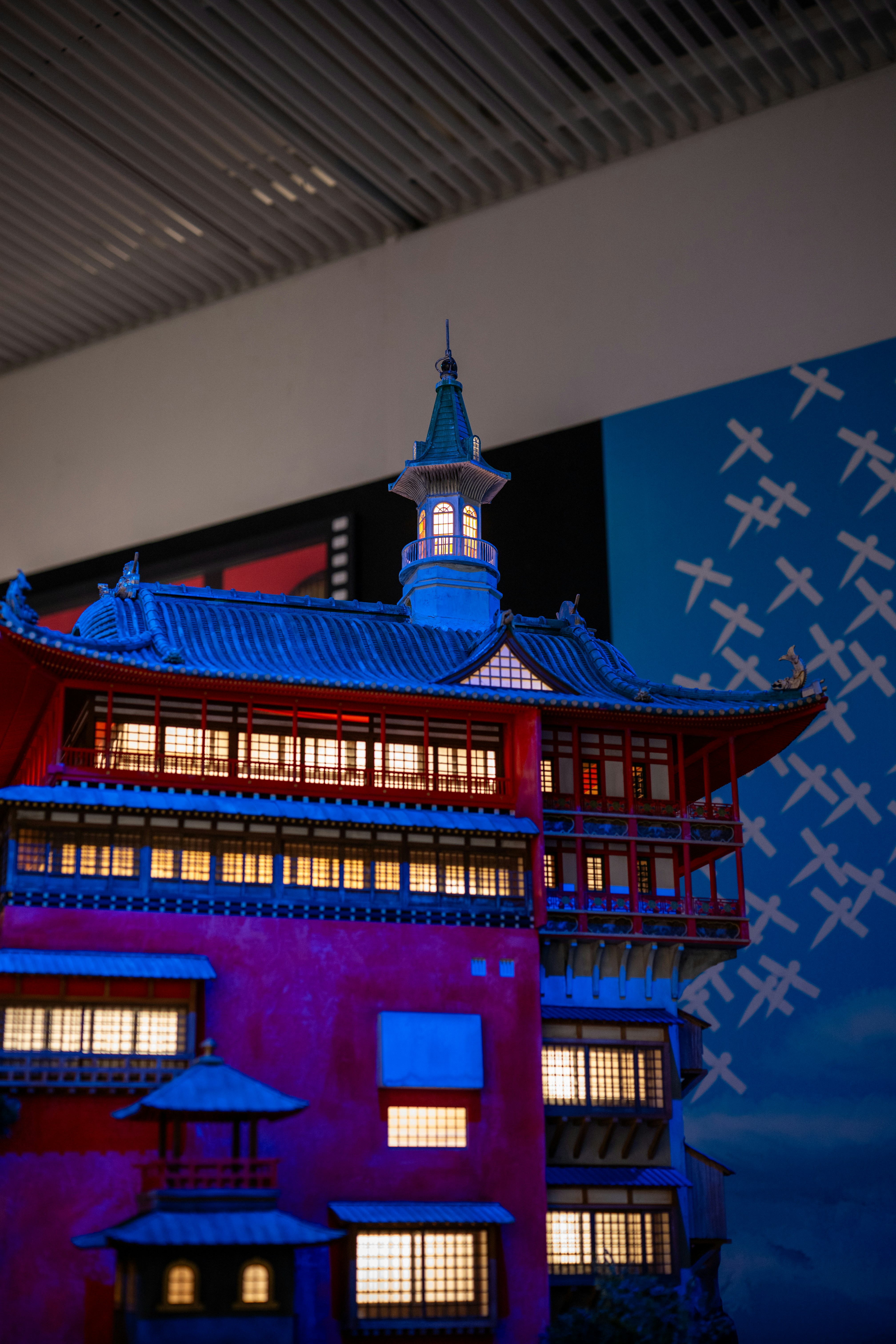 Neon-Tinted Pagoda: A Violet-Blue Facade Under Fluorescent Lights