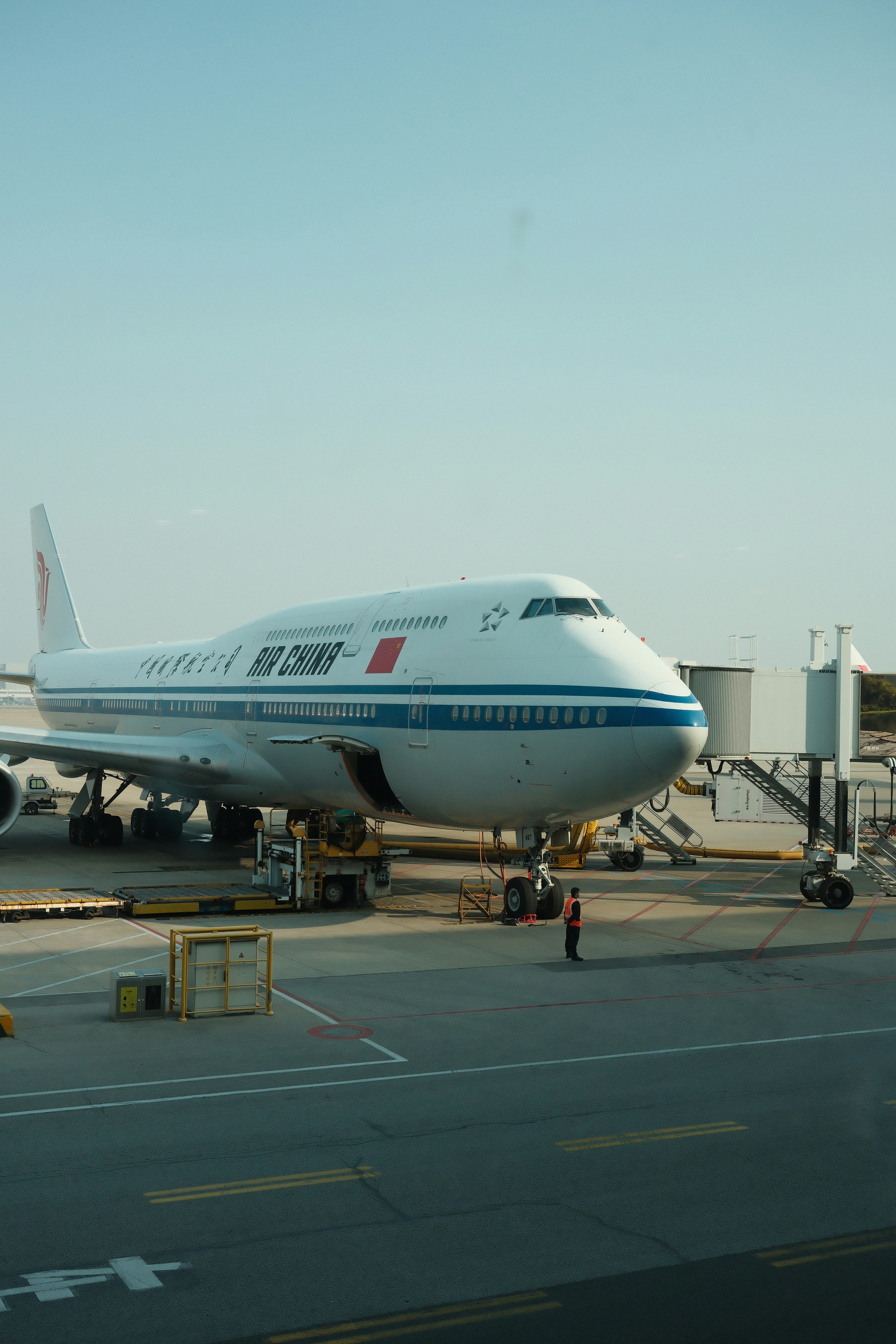 Grounded Giant: A China Eastern jet at the jet bridge under a calm morning sky