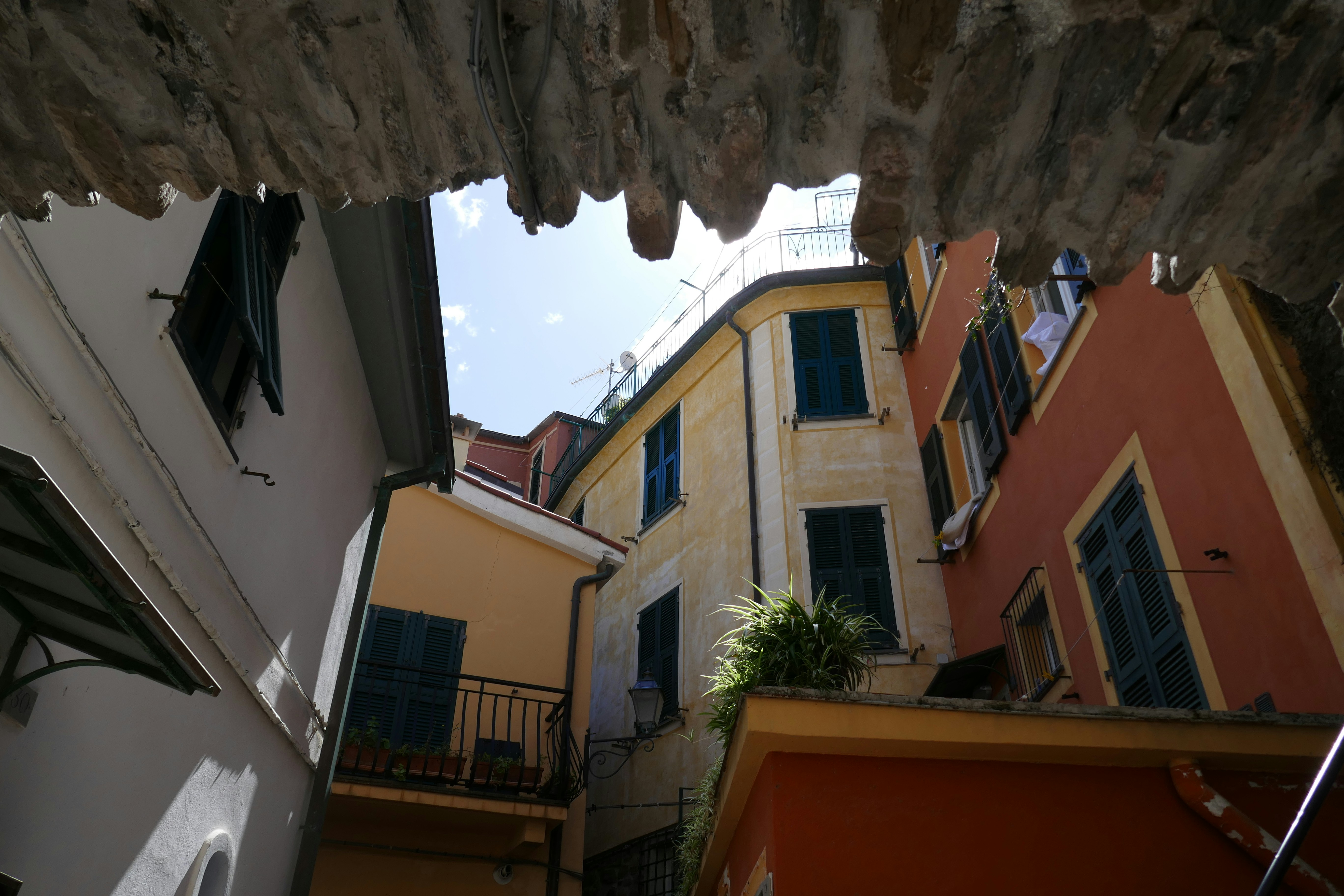 Colorful buildings viewed through an arched stone opening. photo – Free ...