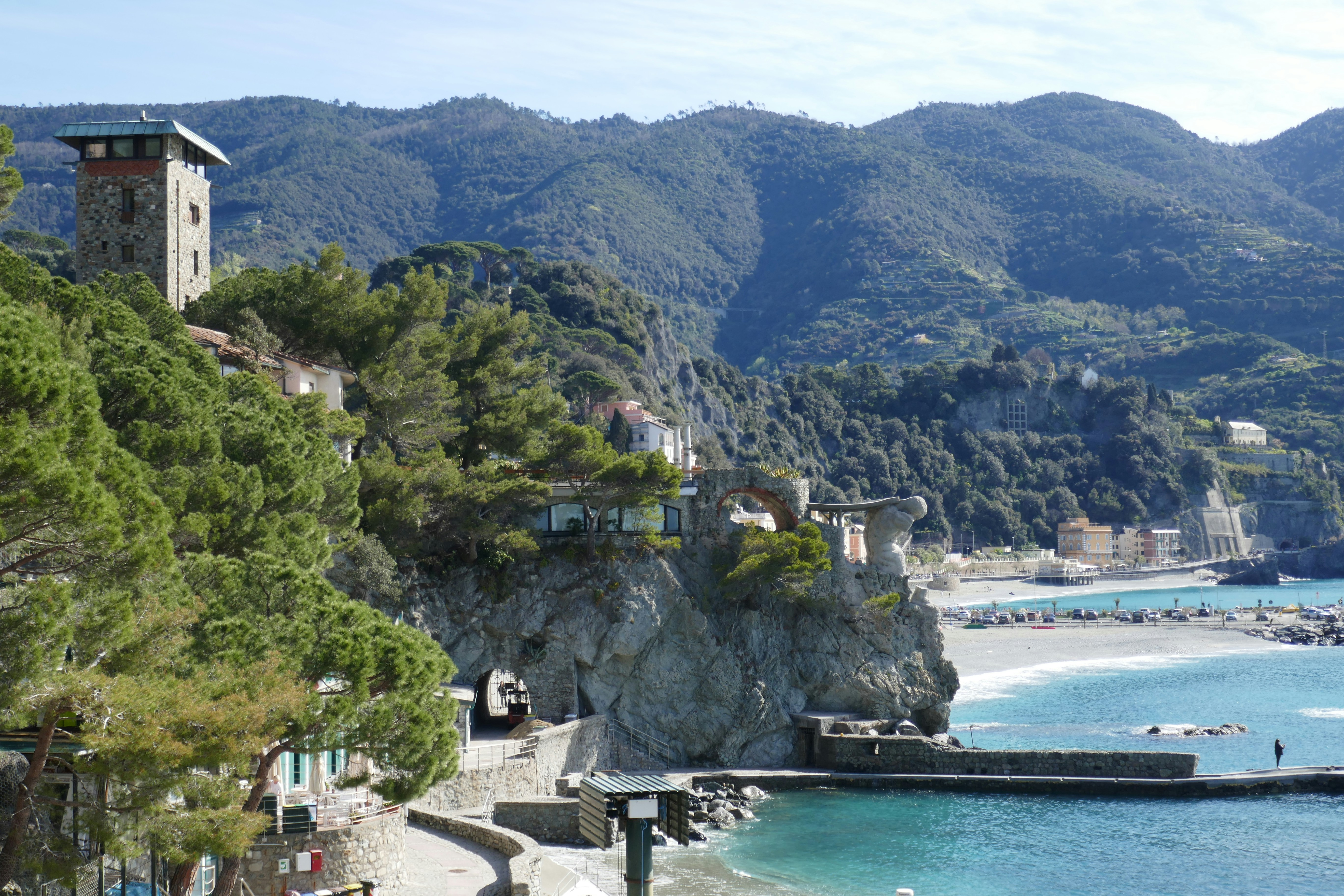 Coastal Village Terrace with Turquoise Bay and Cliffside Stone Structures