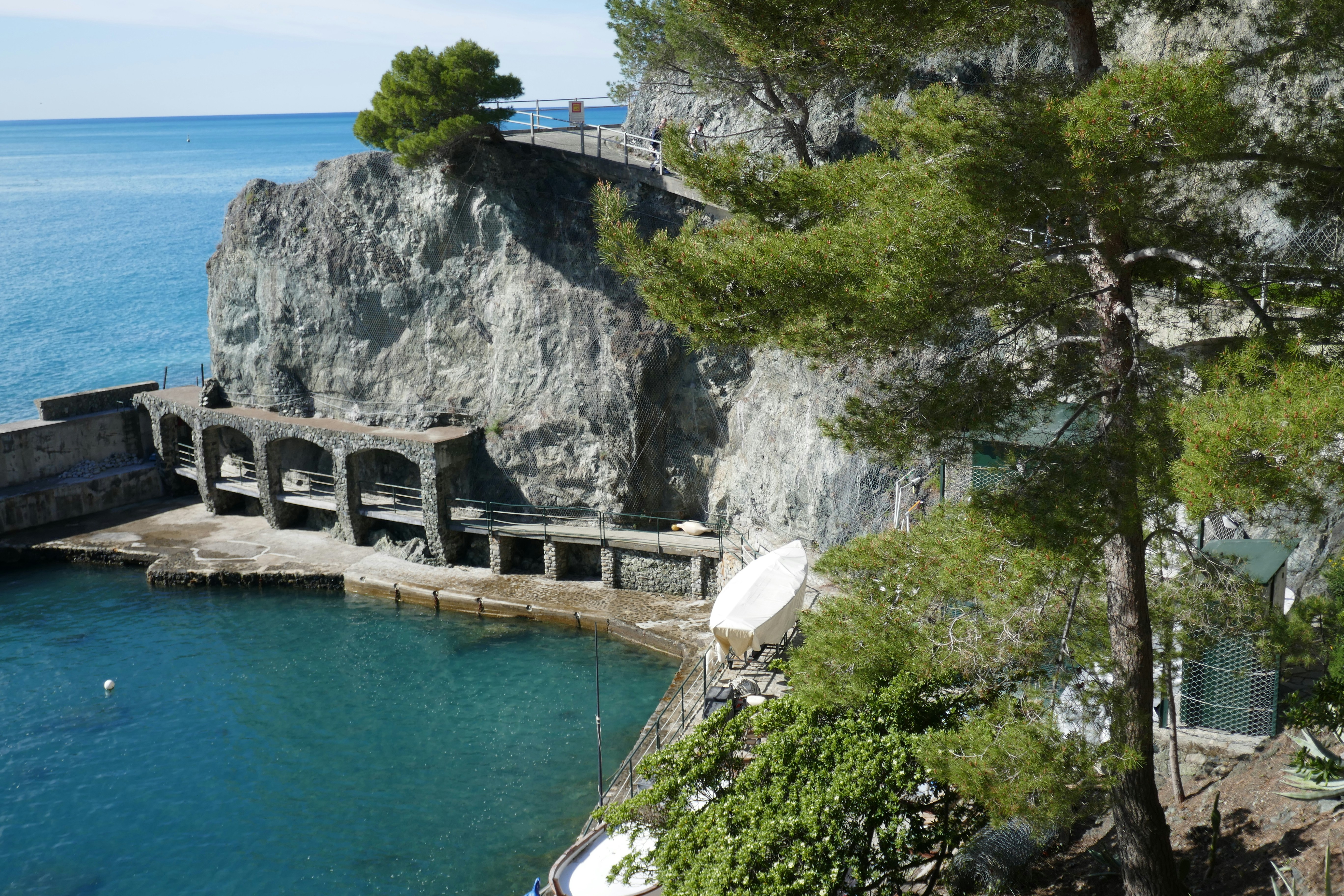 Clifftop Cove: Sunlit Terrace Over Turquoise Waters