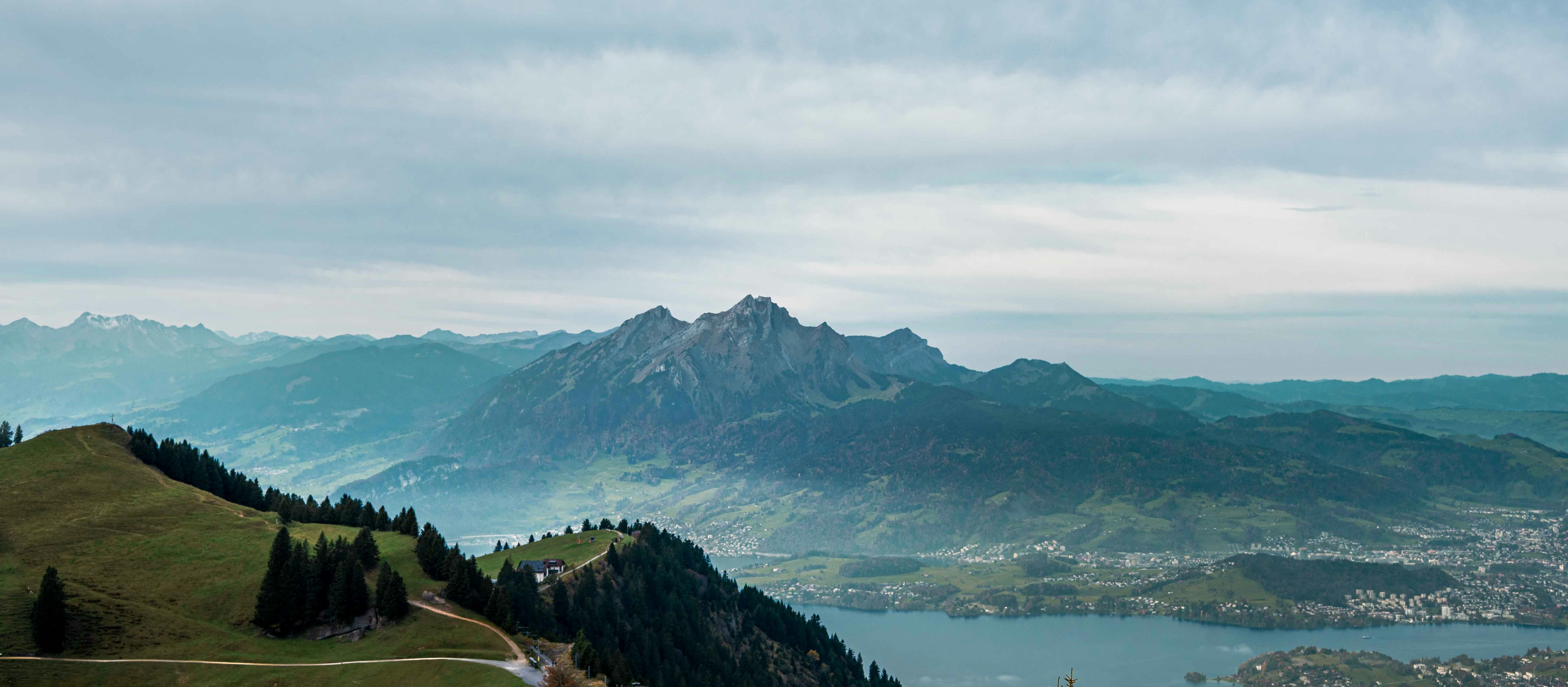 Toward the Blue Rim: Distant Alps Over a Quiet Lake