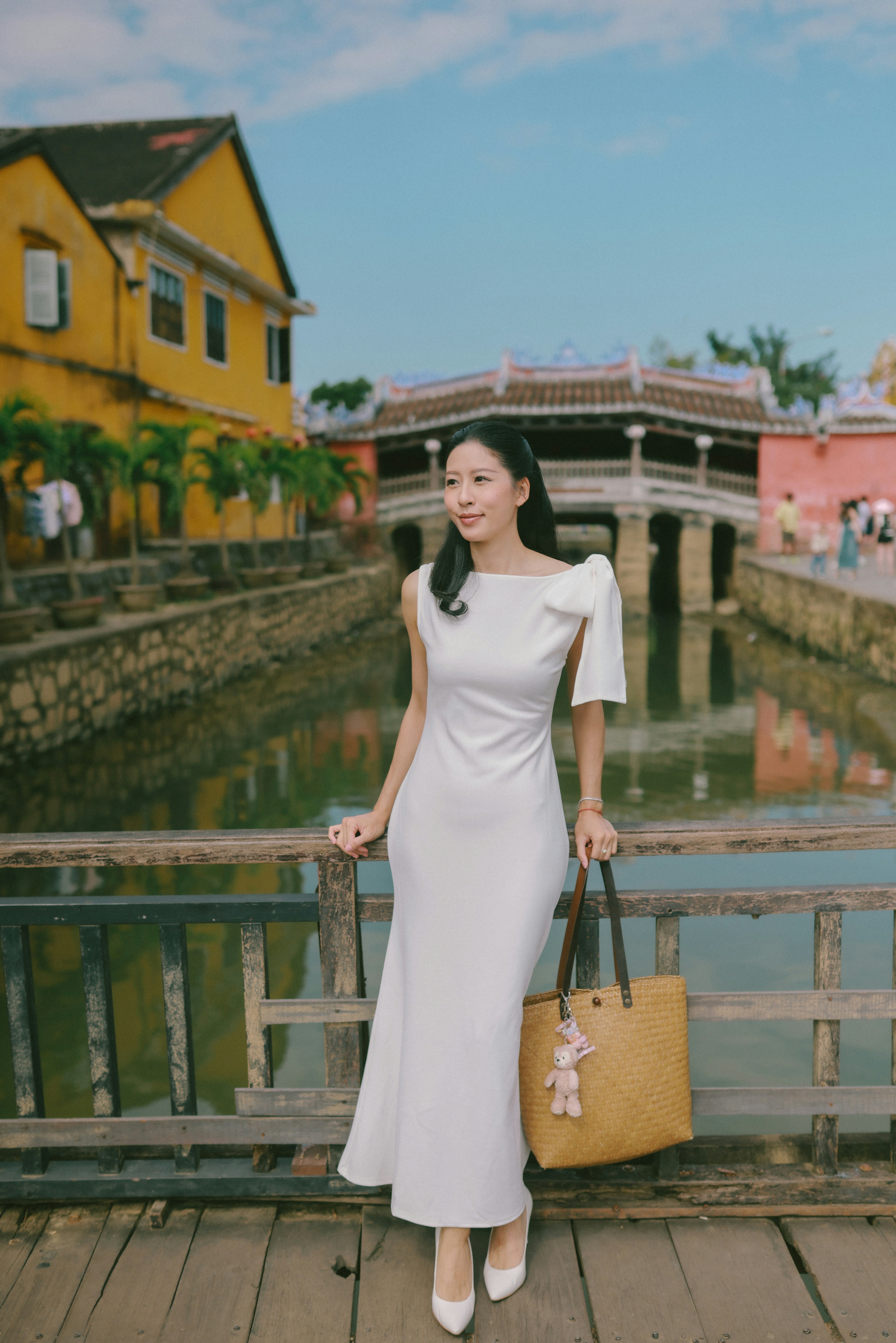 Elegance on the Bridge: A White-Gown Portrait by the Canal