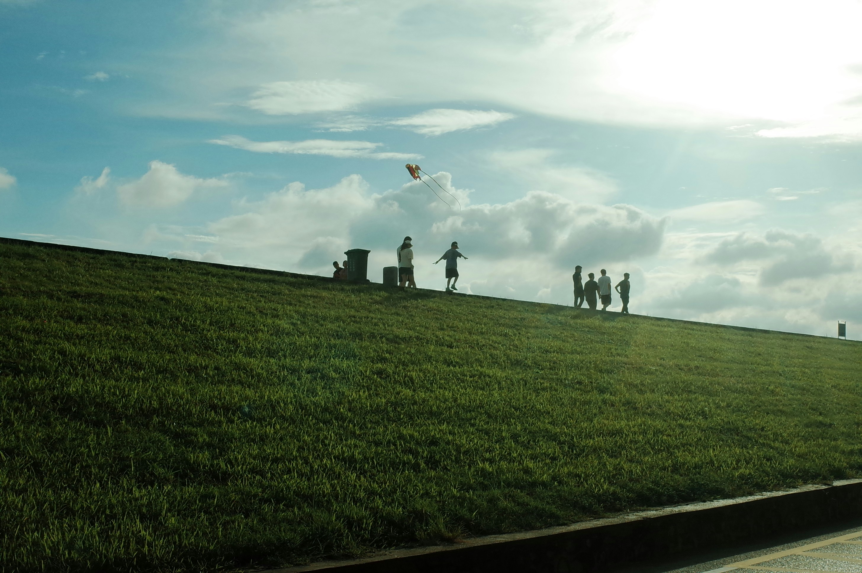 Silhouetted Playground on a Gentle Hill at Dappled Sunset