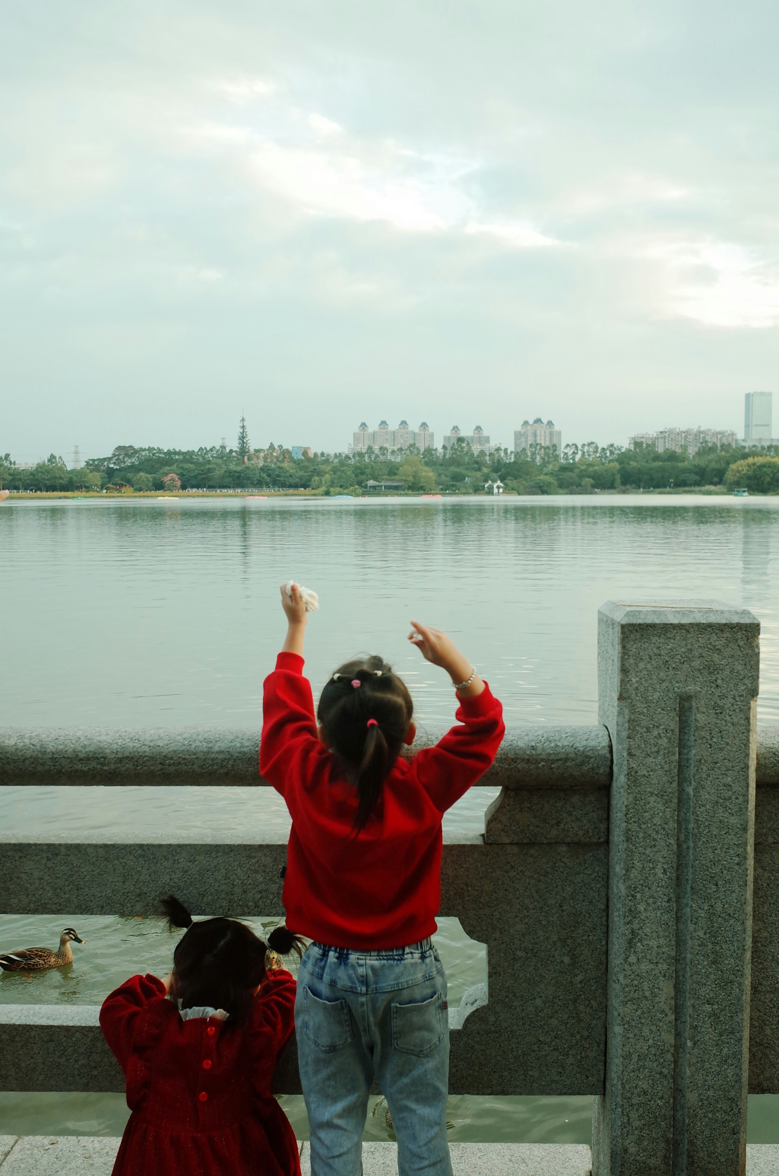Red-clad children at a riverside overlook
