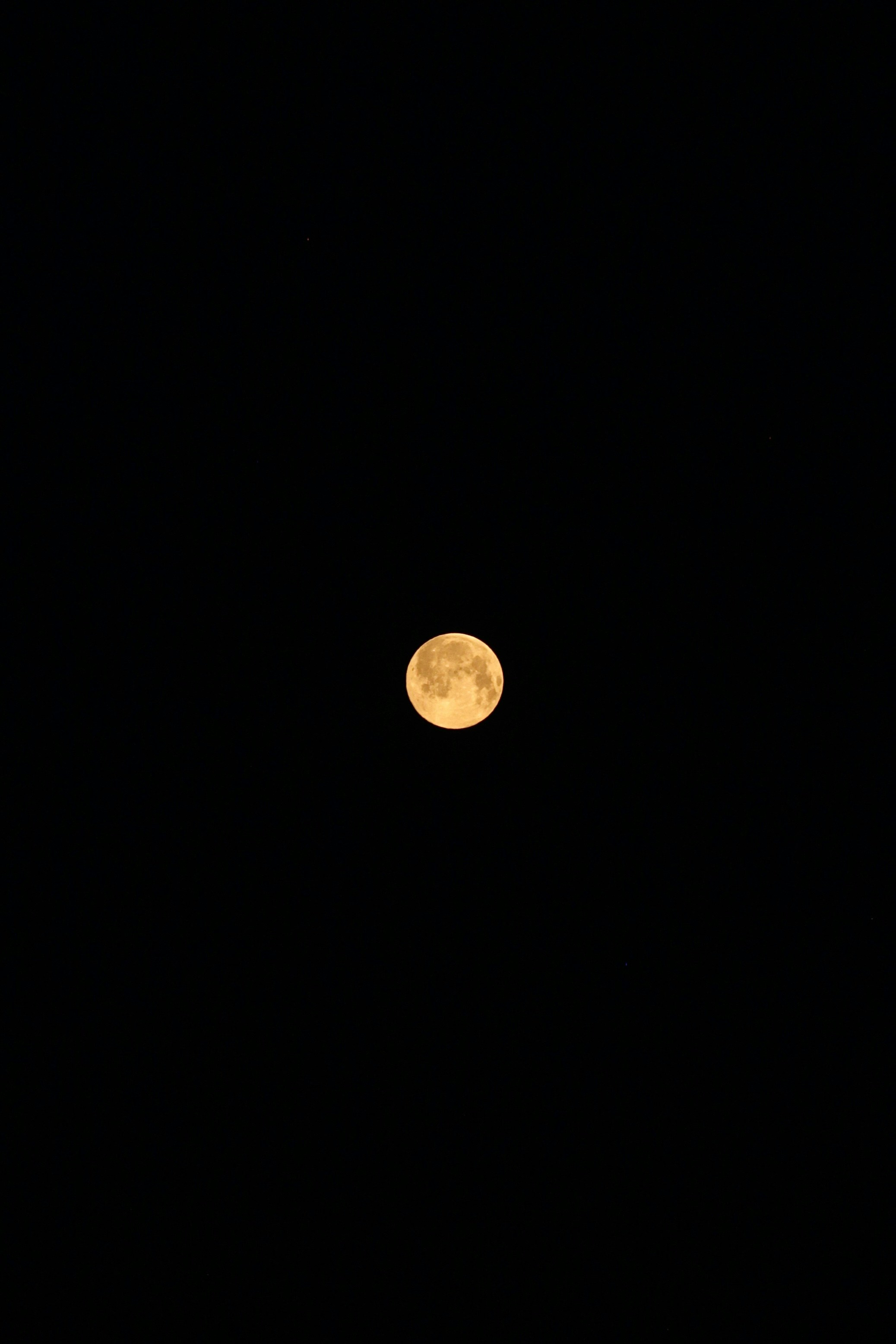 Moonlit Disc of Fire: A lone orange lunar disk in a velvet sky