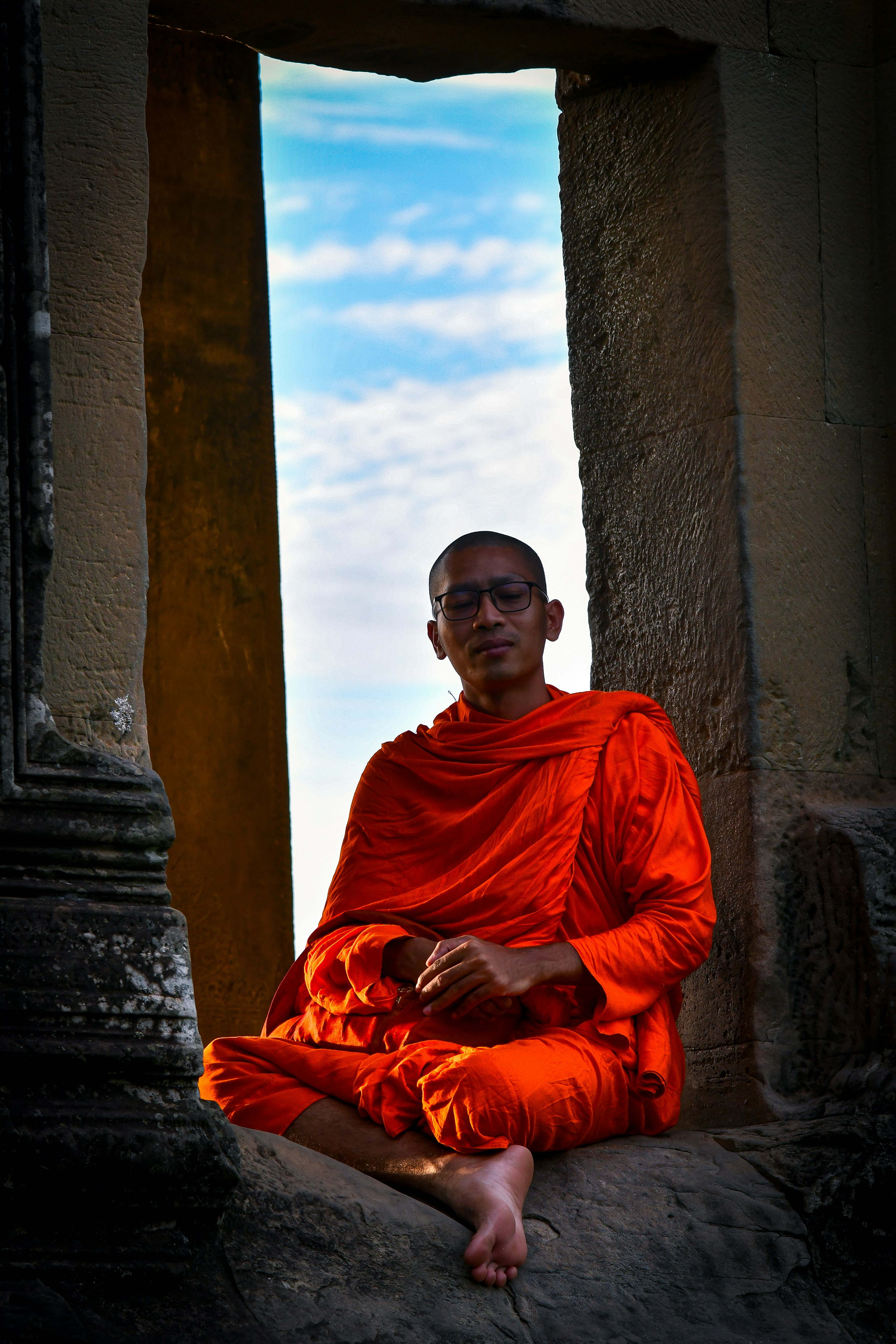 Monk in Scarlet Light: Meditation Amid Stone Arches