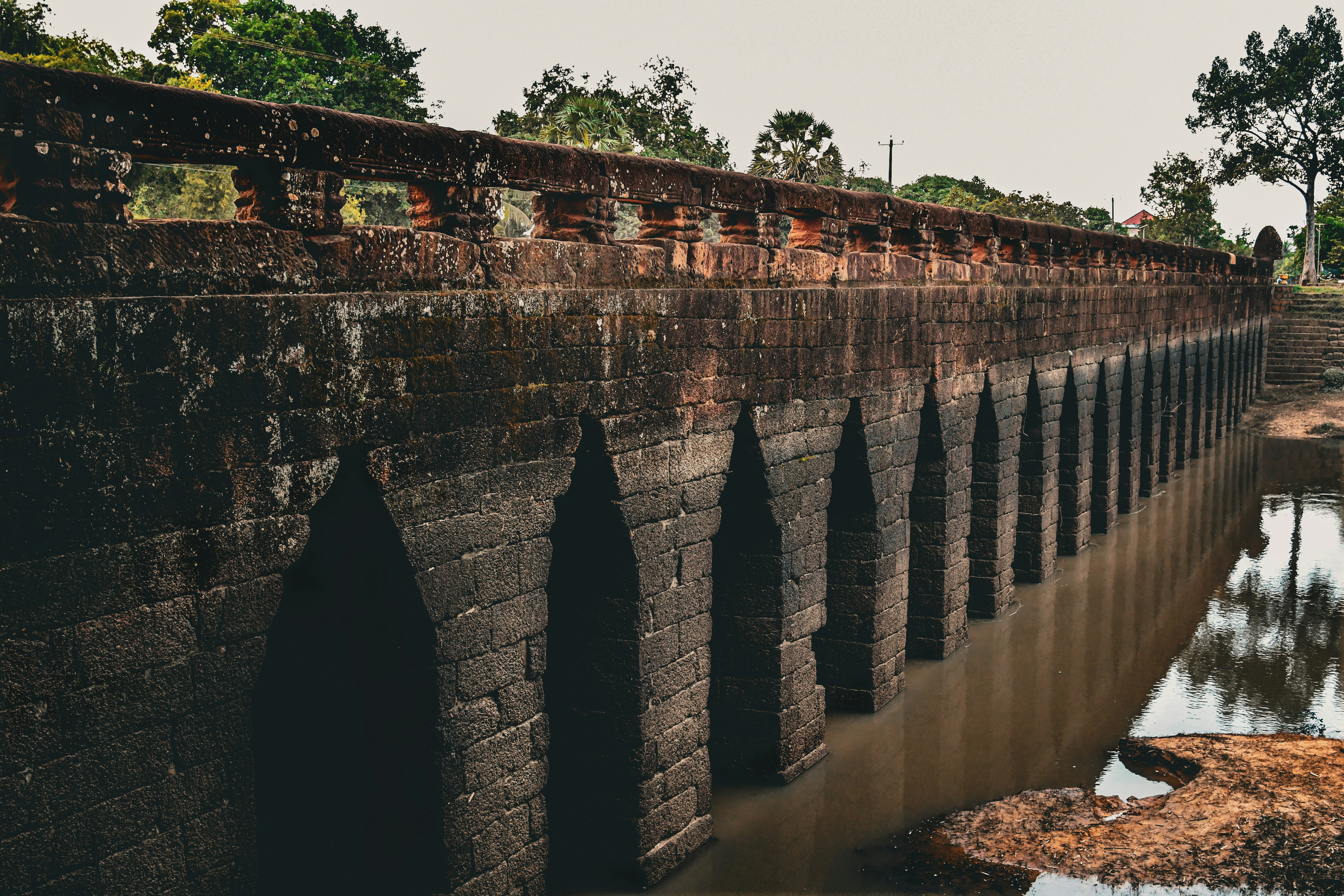 Sunlit Arches: An Ancient Bridge Stretching into Quiet Echoes