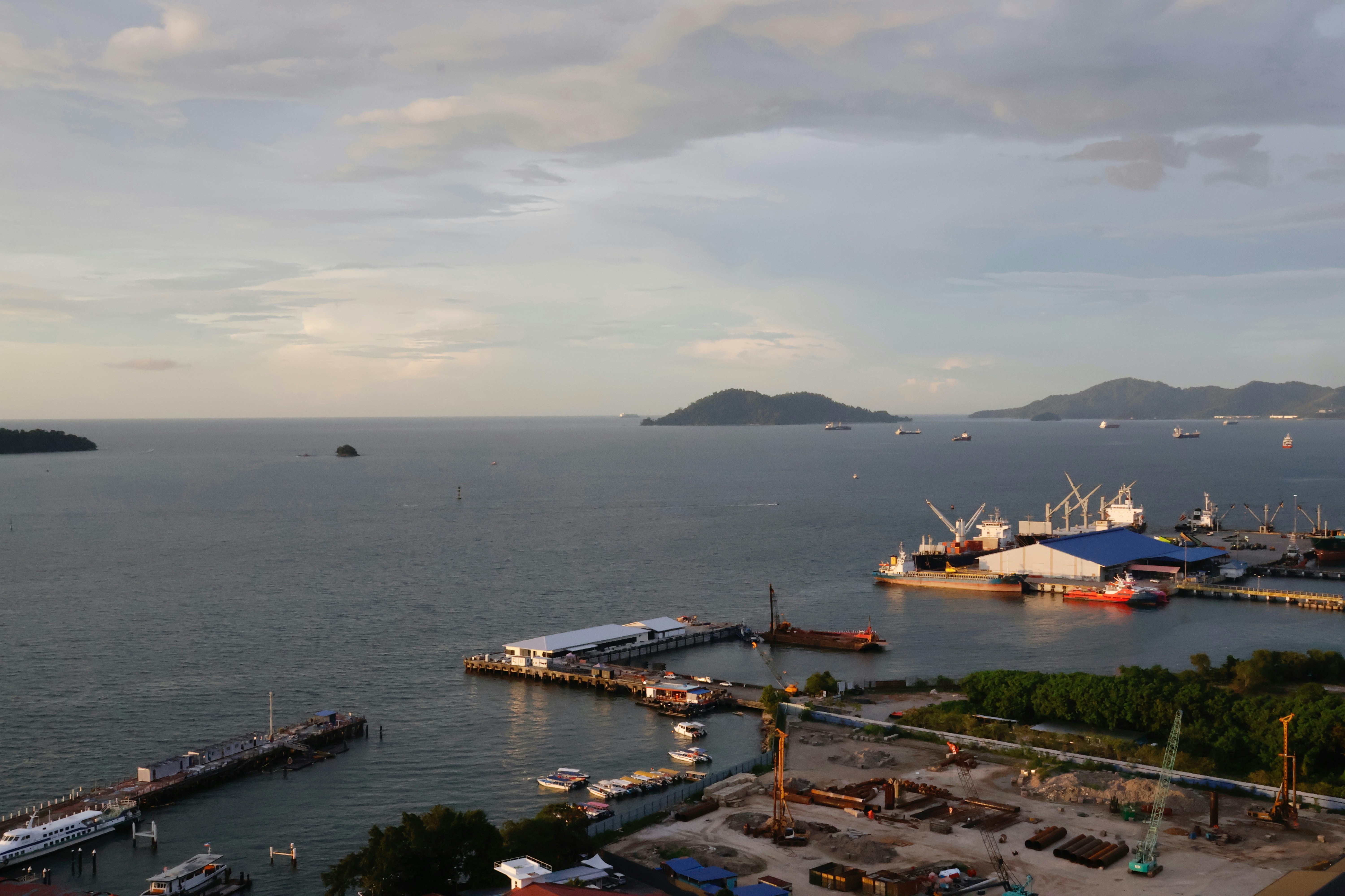 Harbor at Dusk: Boats, Breakwater, and Quiet Islands