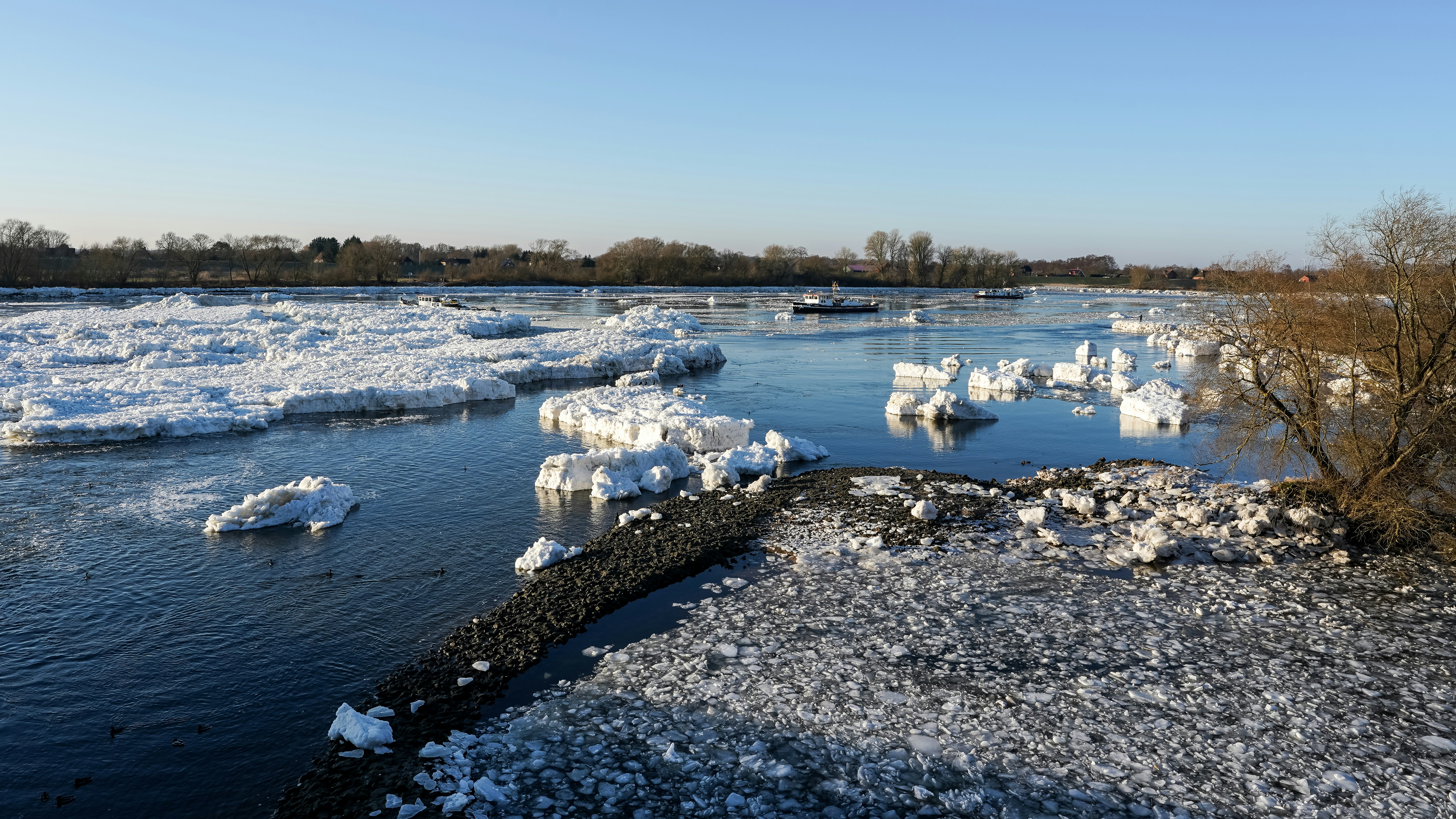 River Verve in Winter Light: Ice Formations along the Pebble Shore