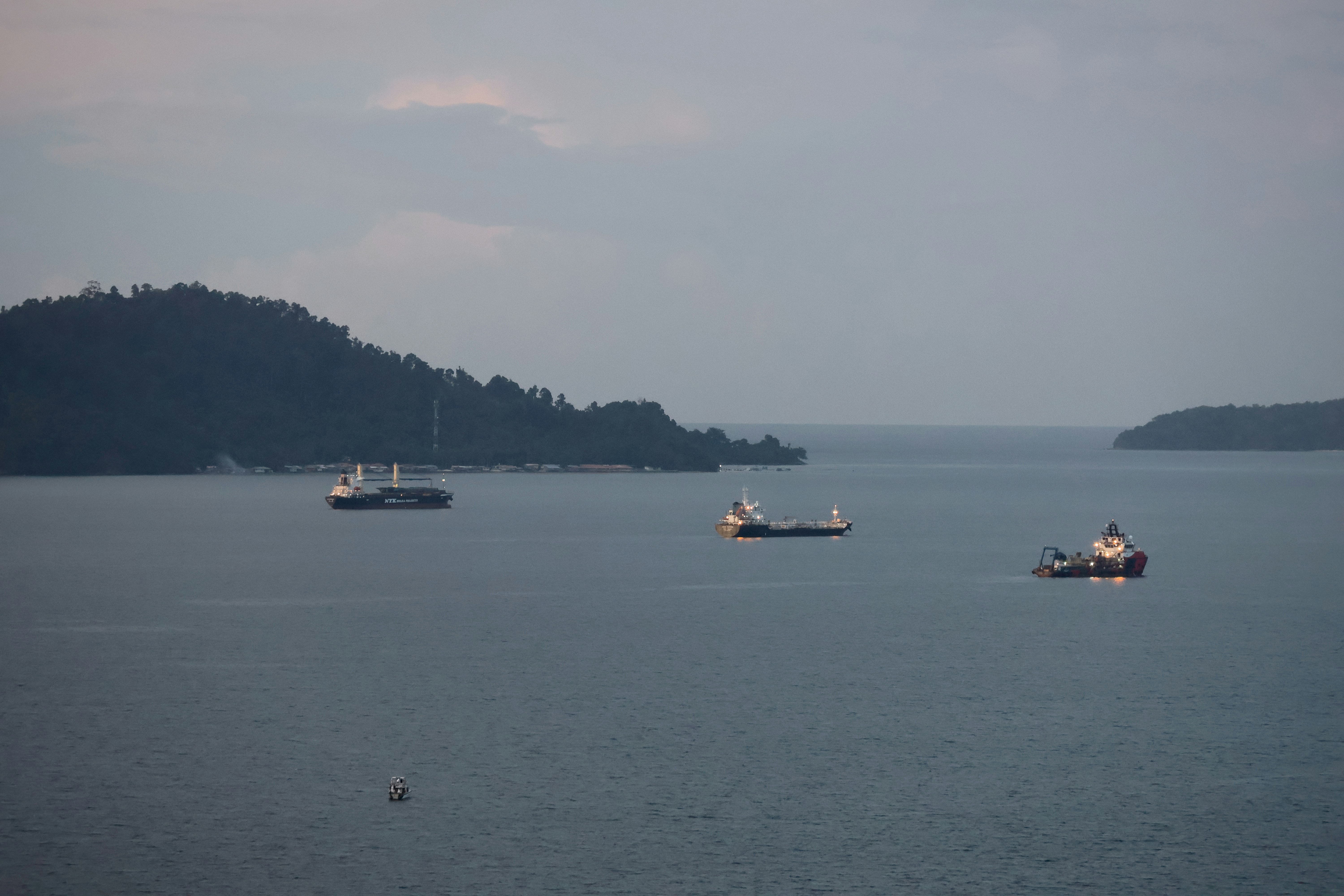Midday Harbor: Boats Dot the Calm Expanse Between Shores
