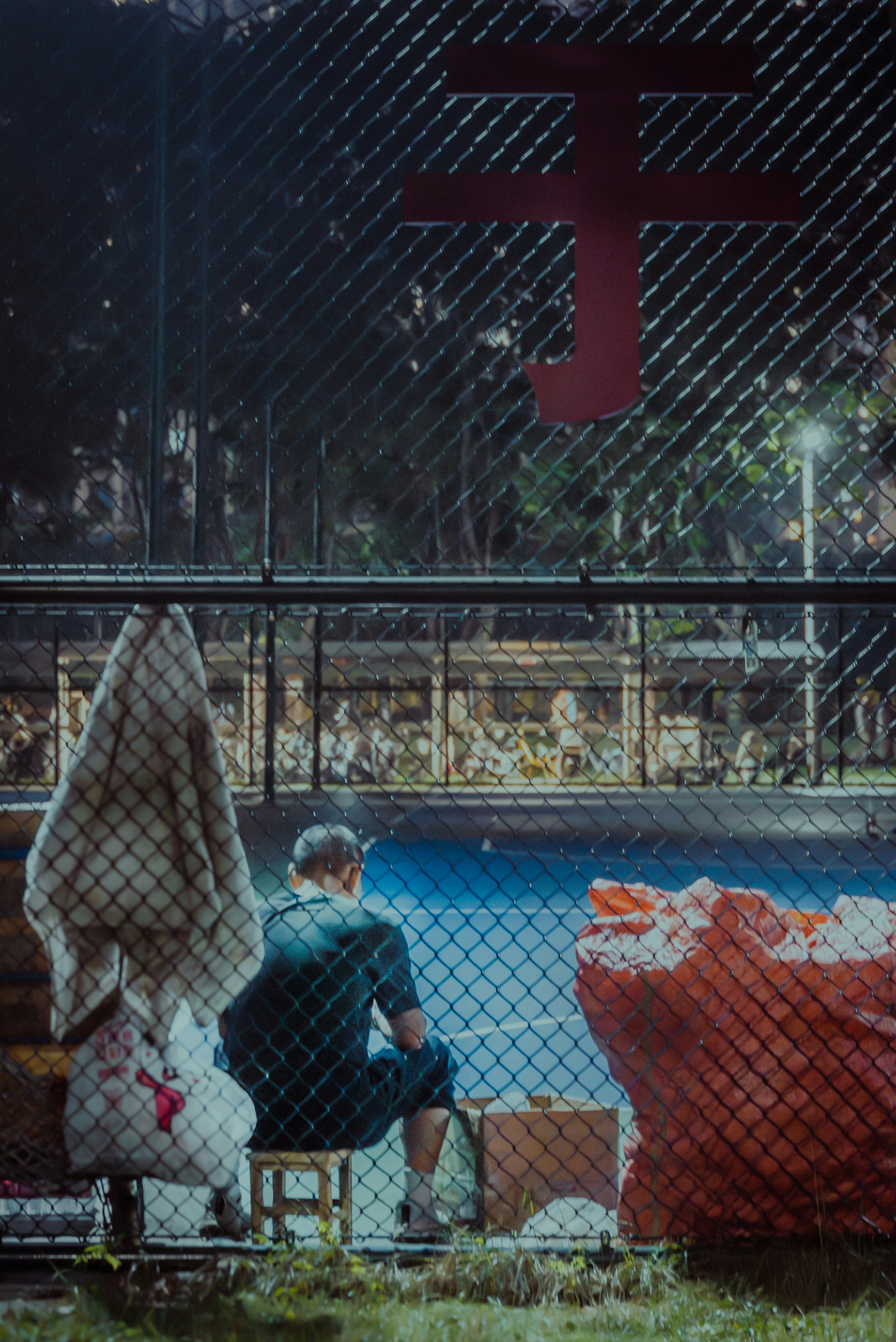 Behind the Fence: Quiet Moment by the Poolside