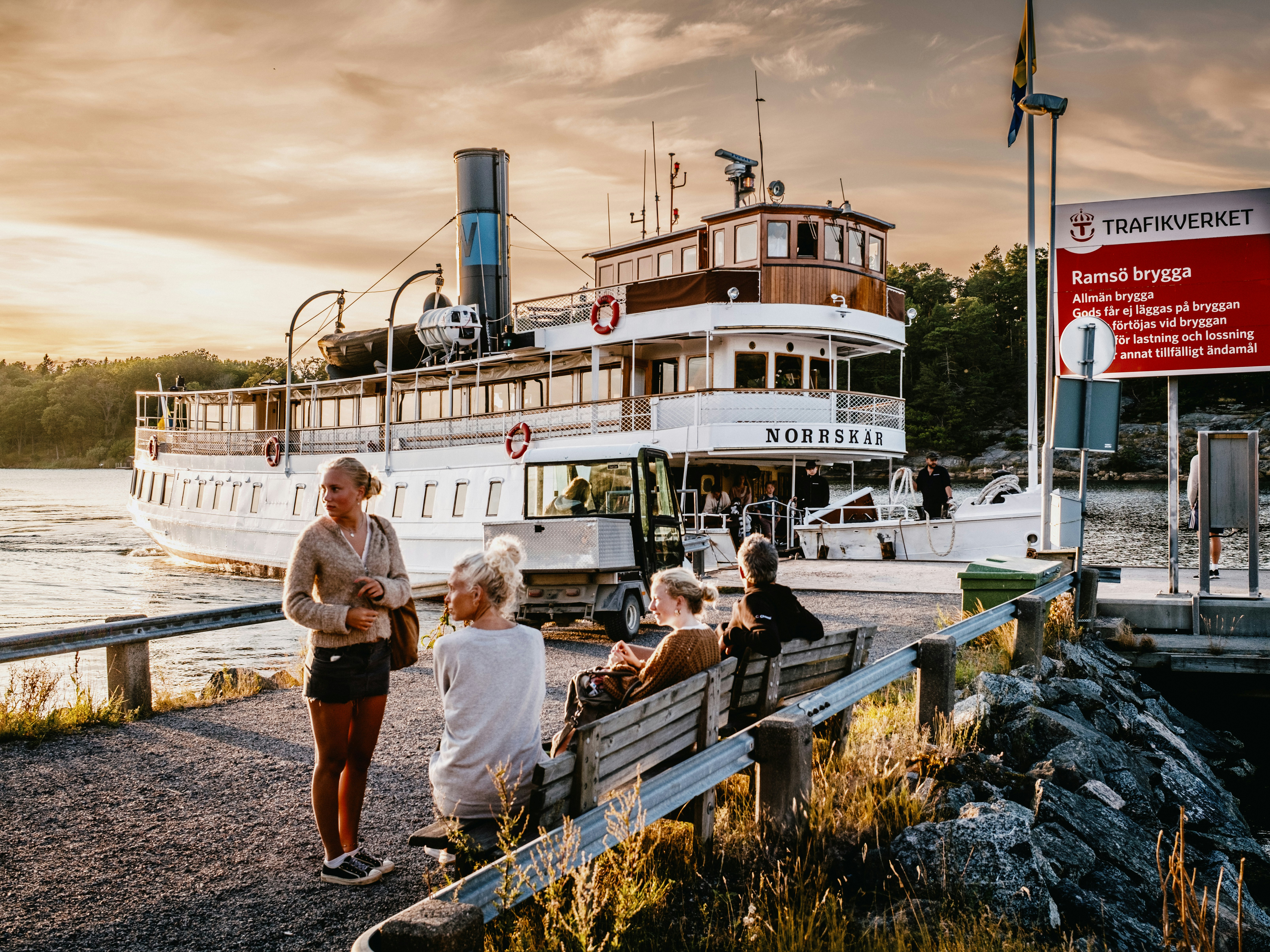 Sunlit Quay: Passengers and Steamship at Dusk