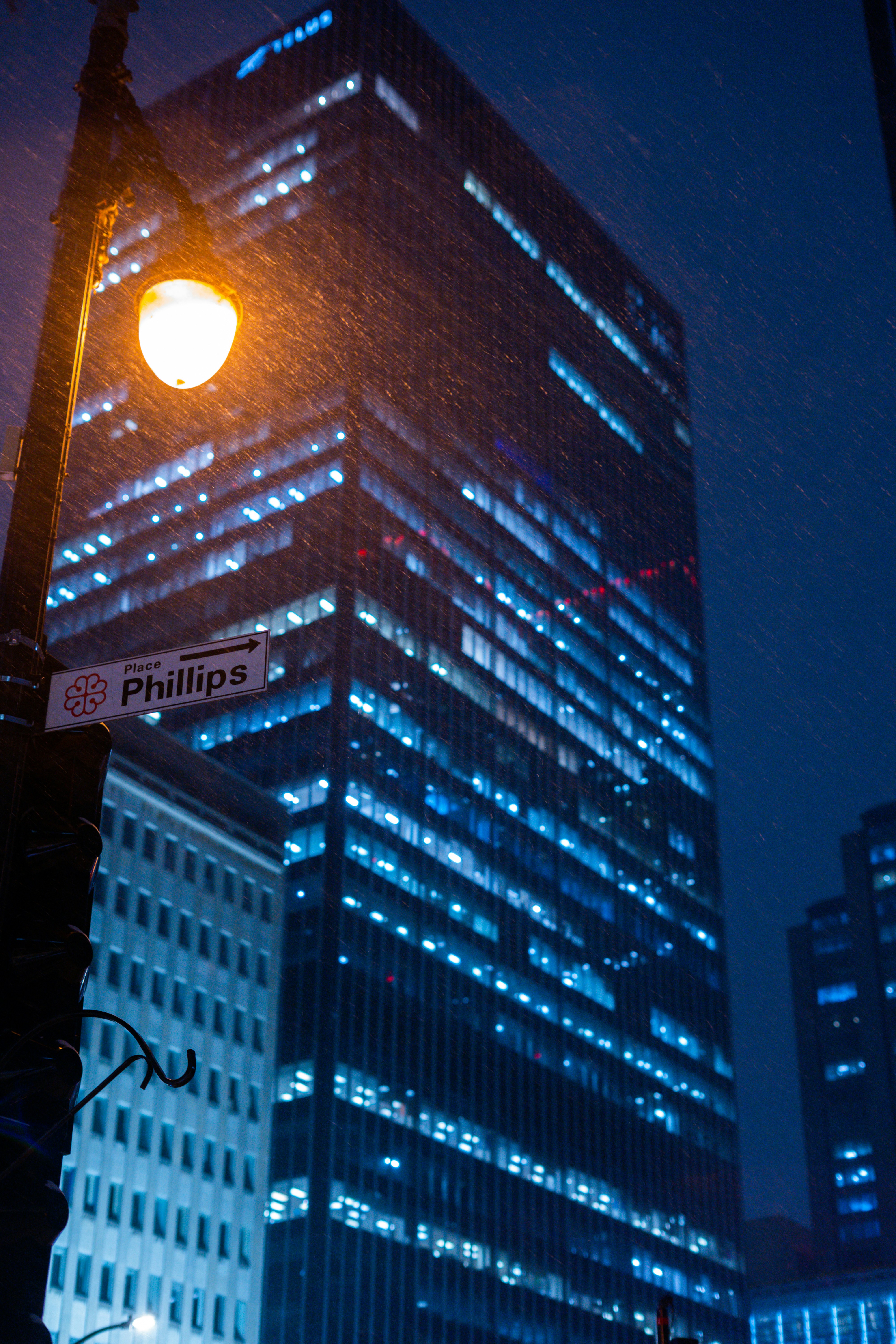 Night Spark: Neon Facade Under Snowy Rain on Phillips Street