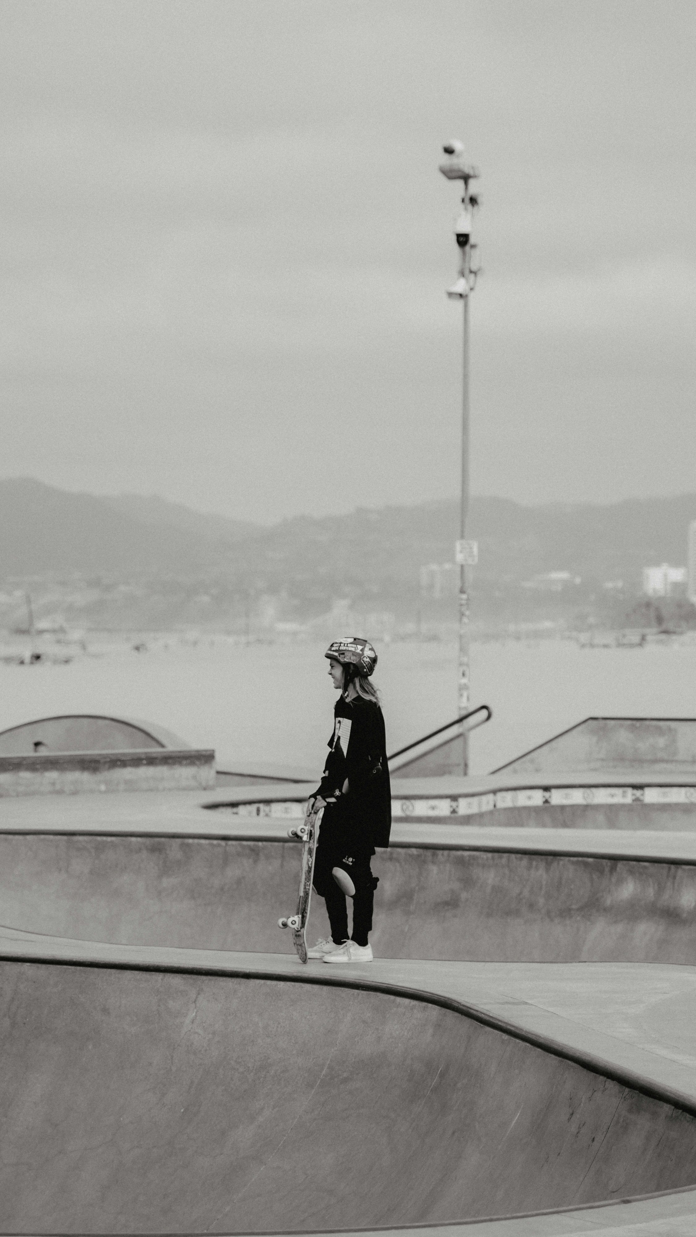 Skateboarder at the Edge: A Quiet Moment in a Concrete Park
