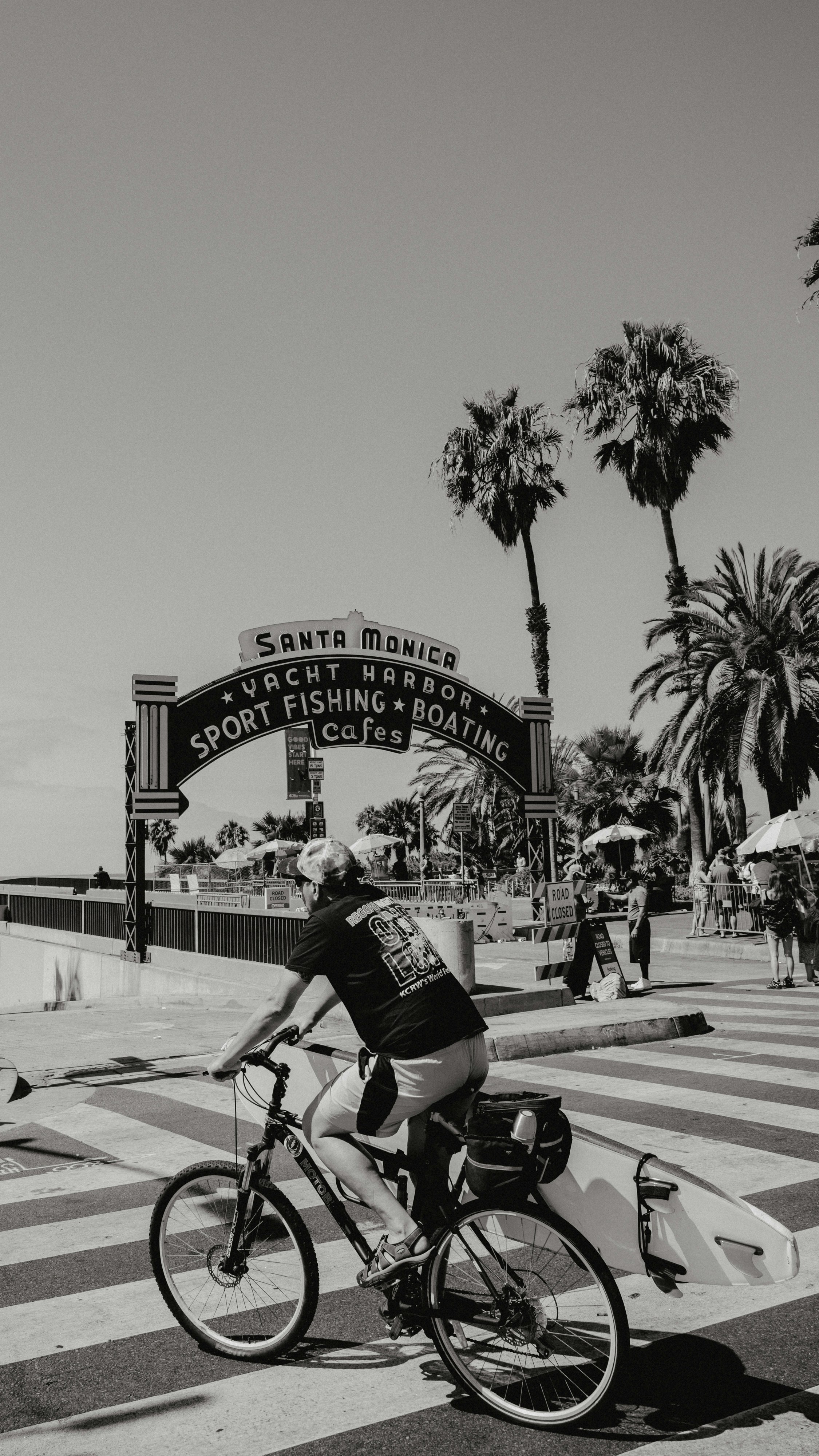 Cyclist and Surfboard at Santa Monica Pier Arch