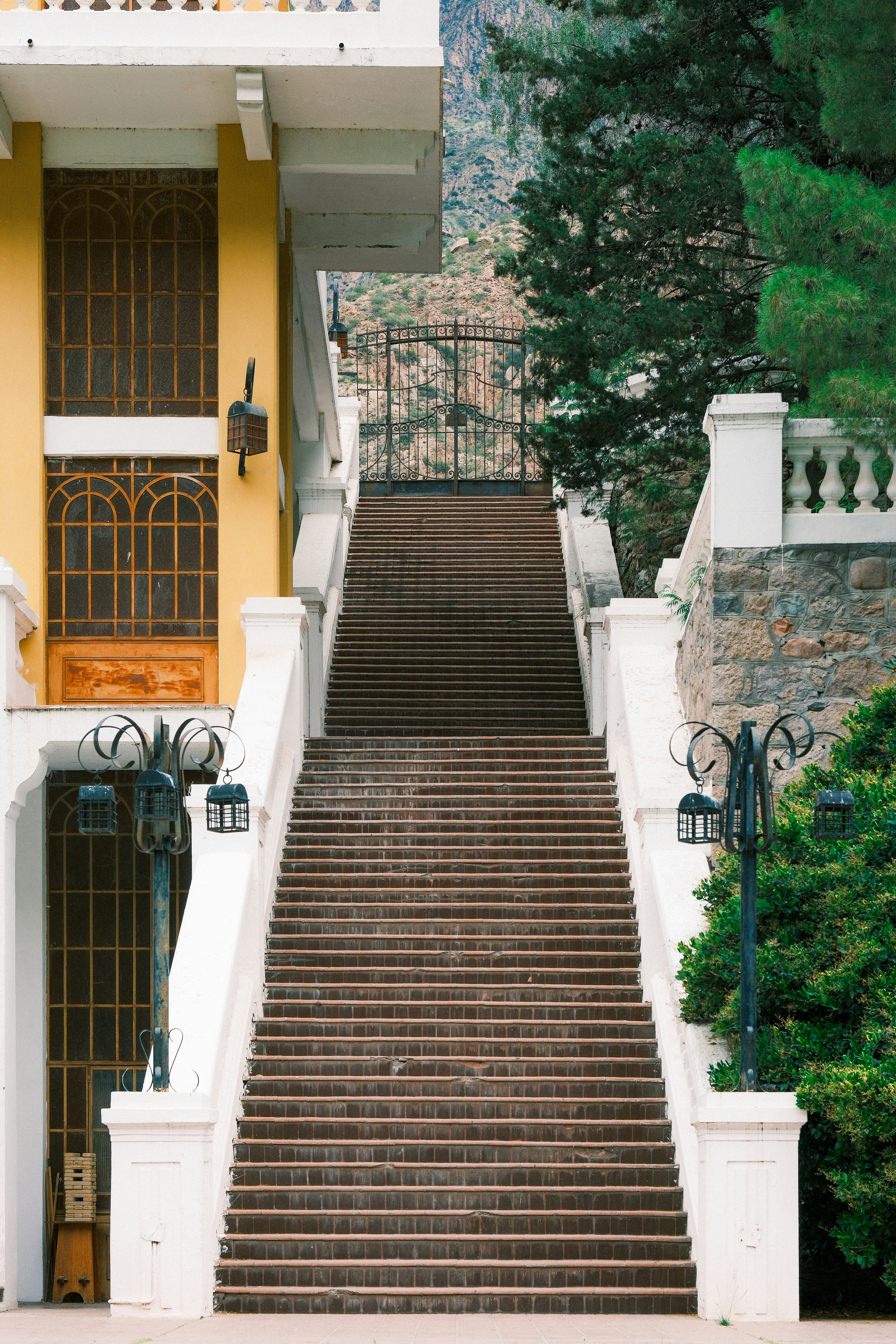 Staircase to Serenity: A Sunny Villa Entrance Framed by Lanterns and Greenery