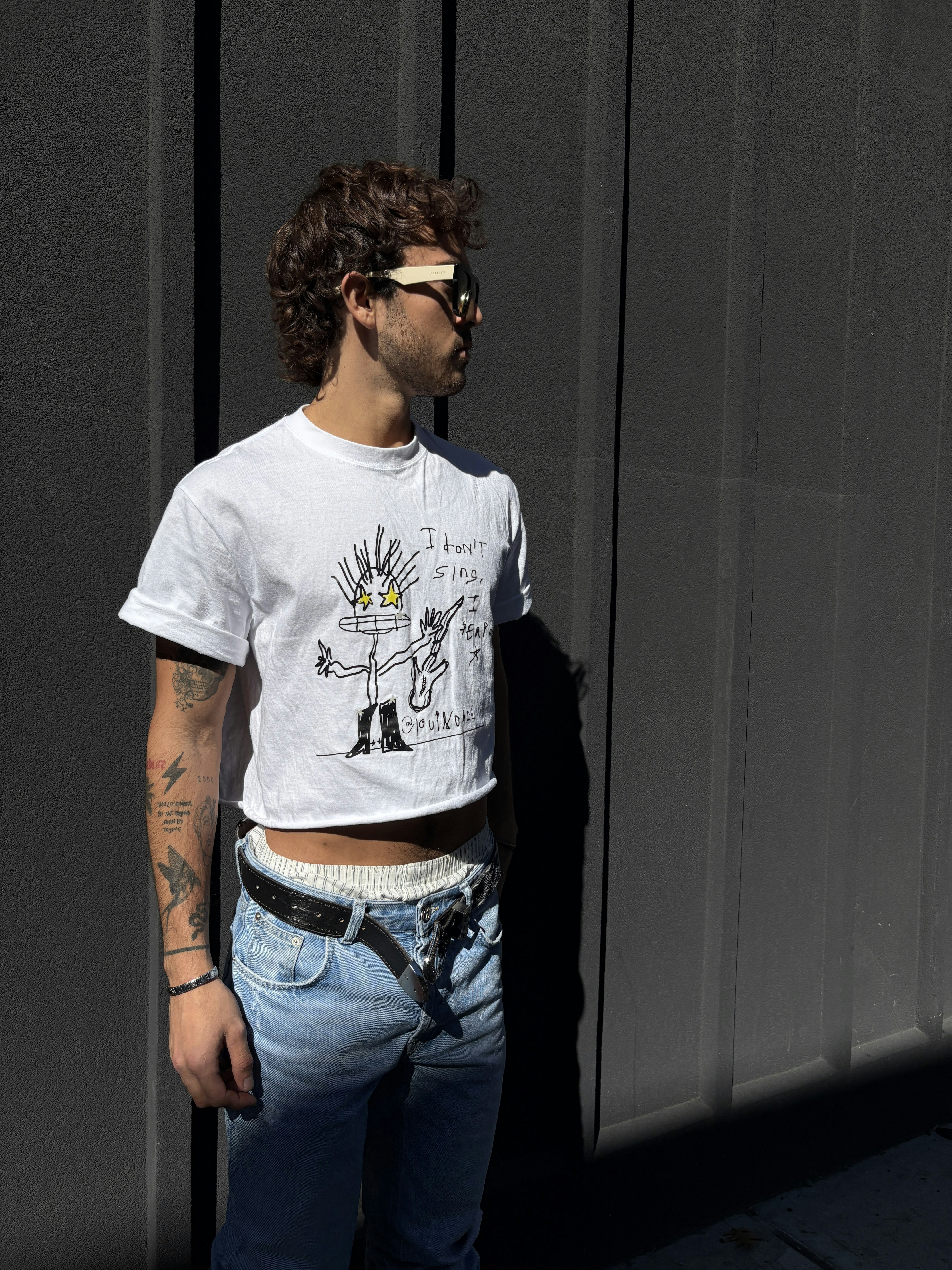 Sunlit Rebel: A Cropped Portrait by the Wall
