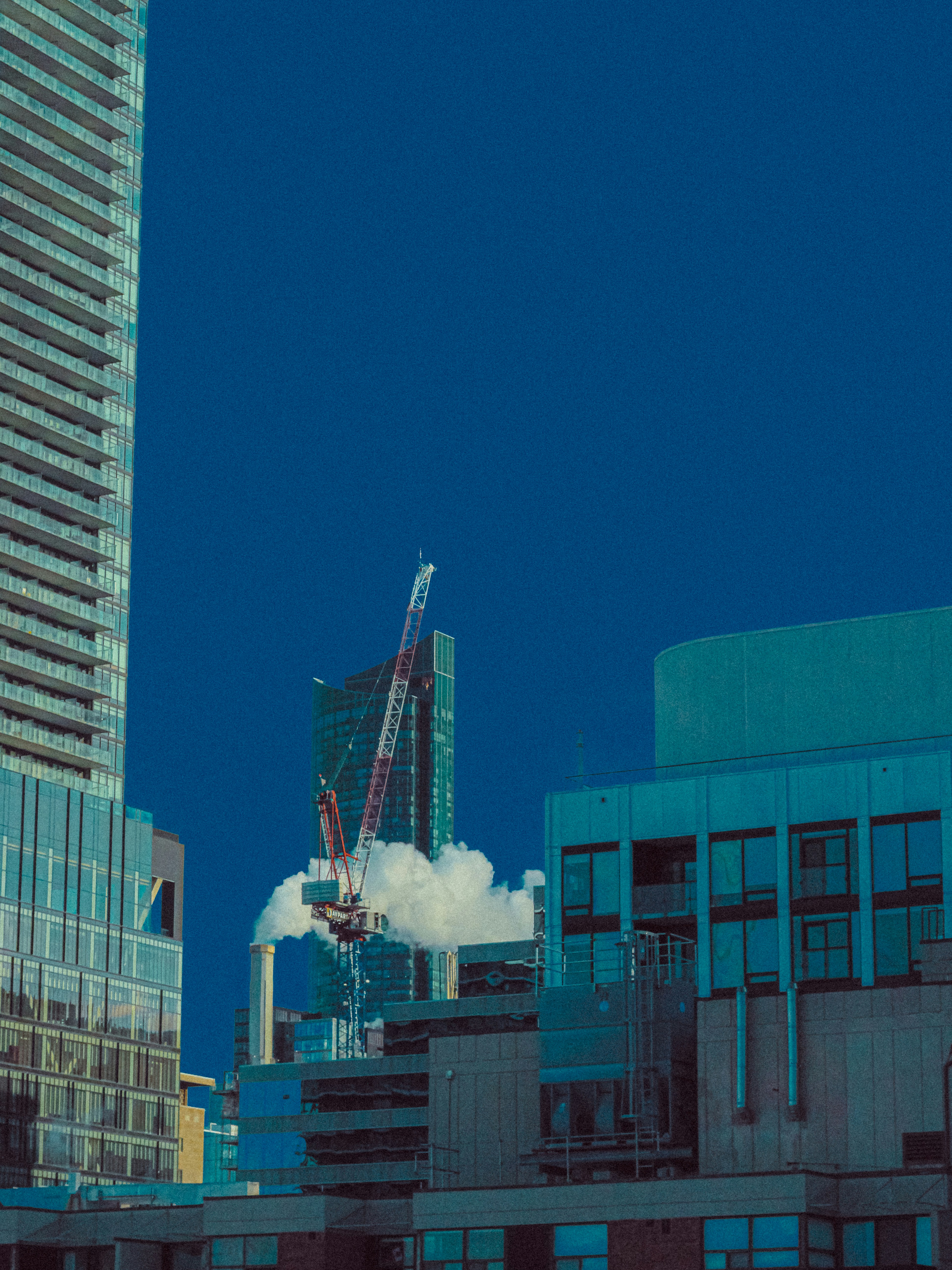 Crane Pulse Over the Blue Cityscape